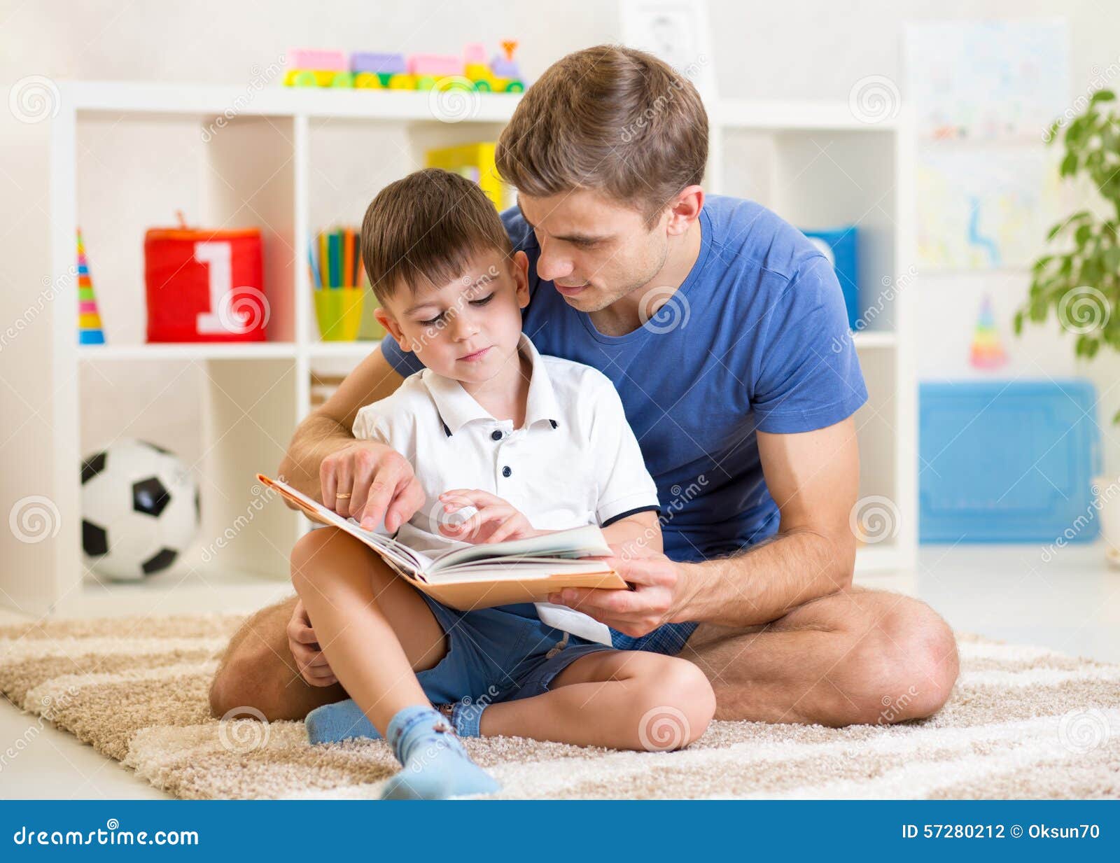 Kid Boy and Father Read a Book on Floor Indoors Stock Photo - Image of ...