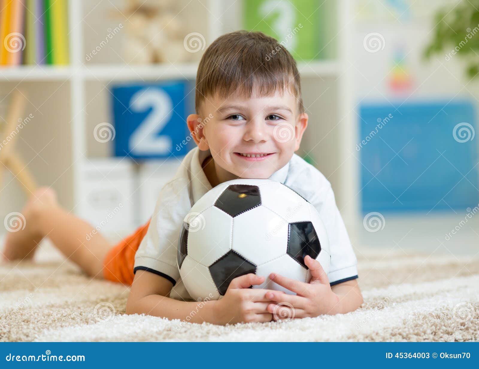 Kid Boy with Football Indoor Stock Image - Image of male, childhood ...