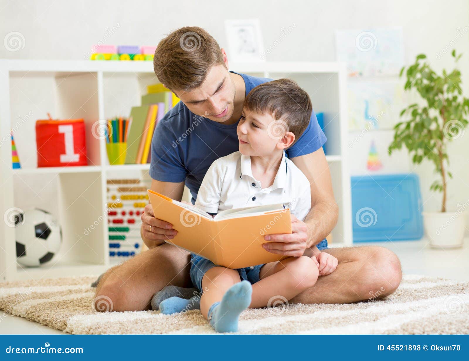 Kid Boy and His Father Read a Book on Floor at Home Stock Photo - Image ...