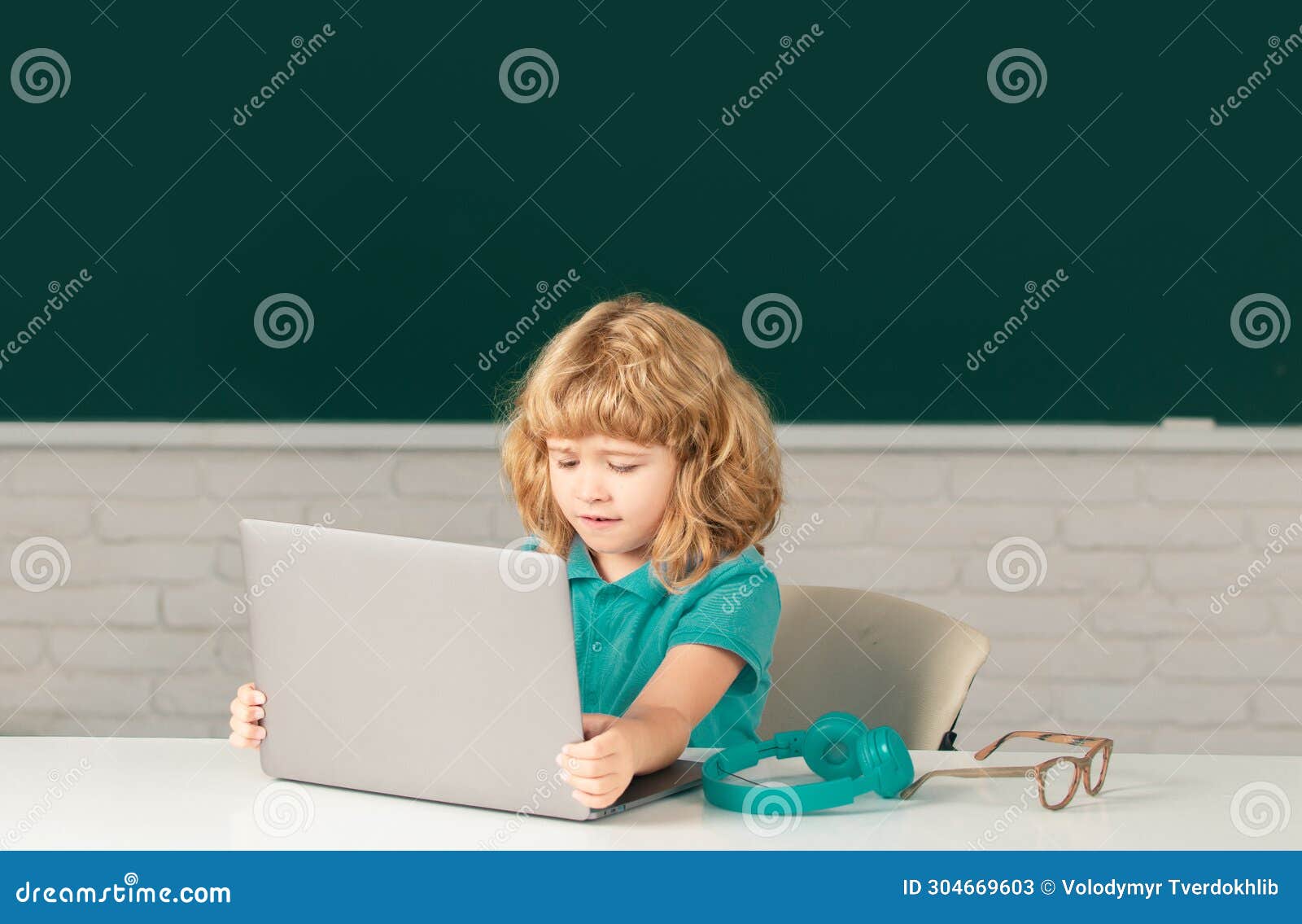 Kid Boy Learning Lesson at School, Making Homework and Using Notebook ...