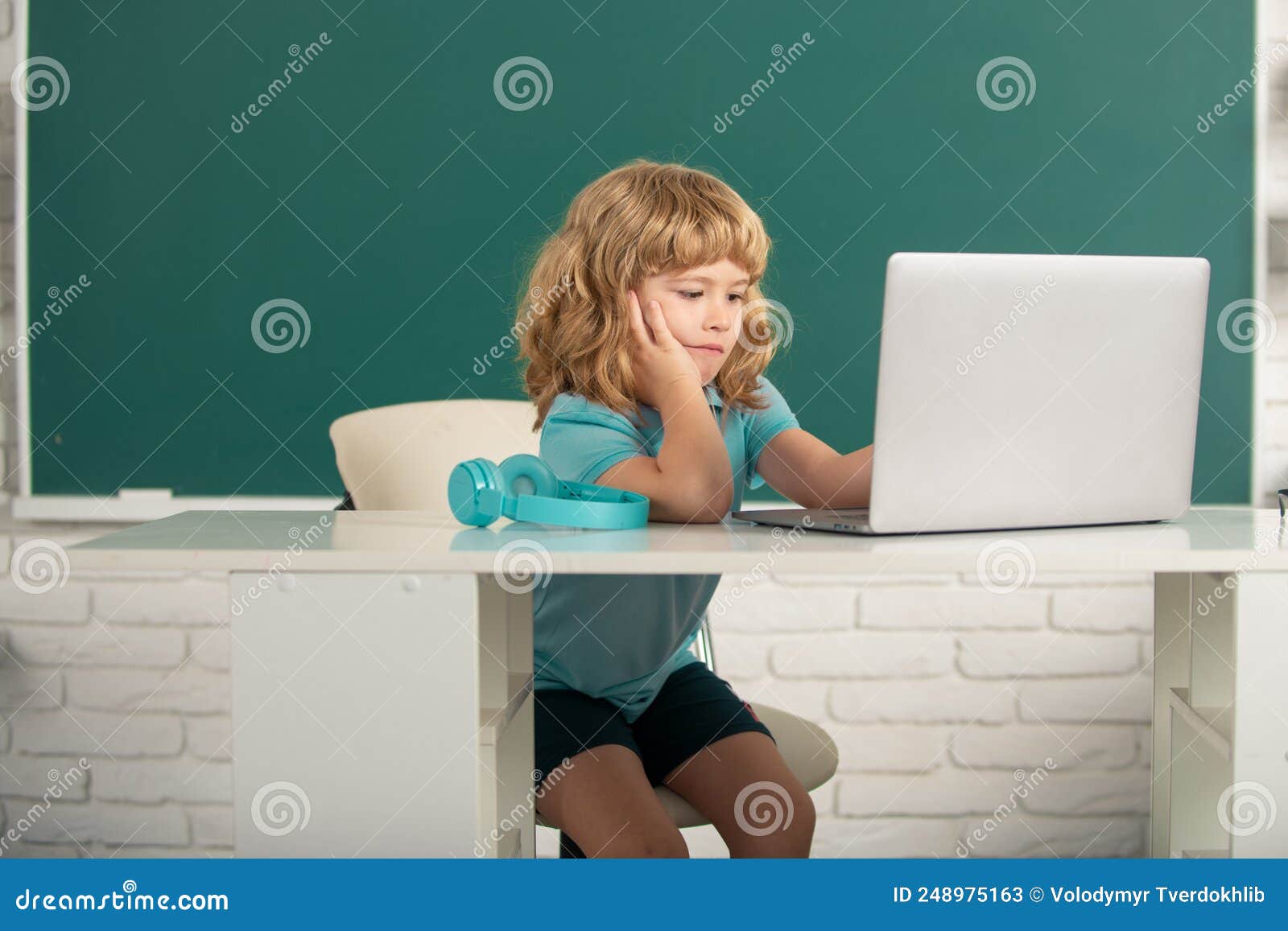 Kid Boy Learning Lesson at School, Making Homework and Using Notebook ...