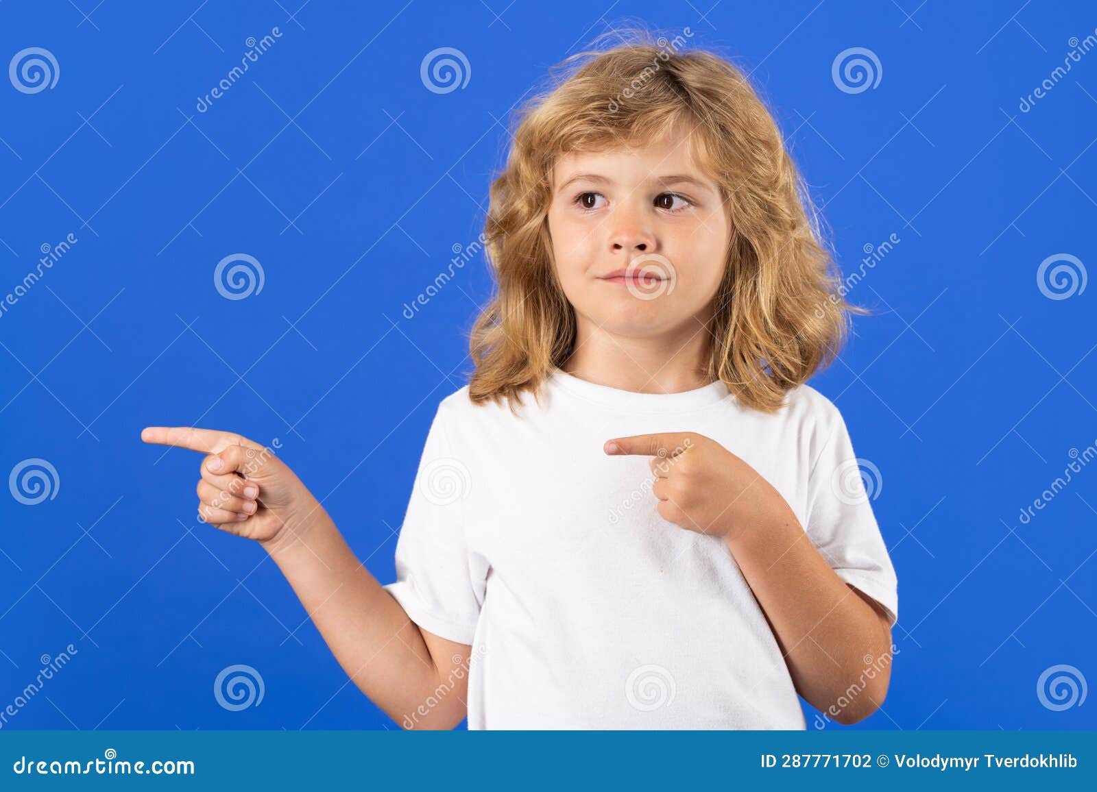 Kid Boy Pointing Away on Blue Isolated Studio Background. Kid with ...