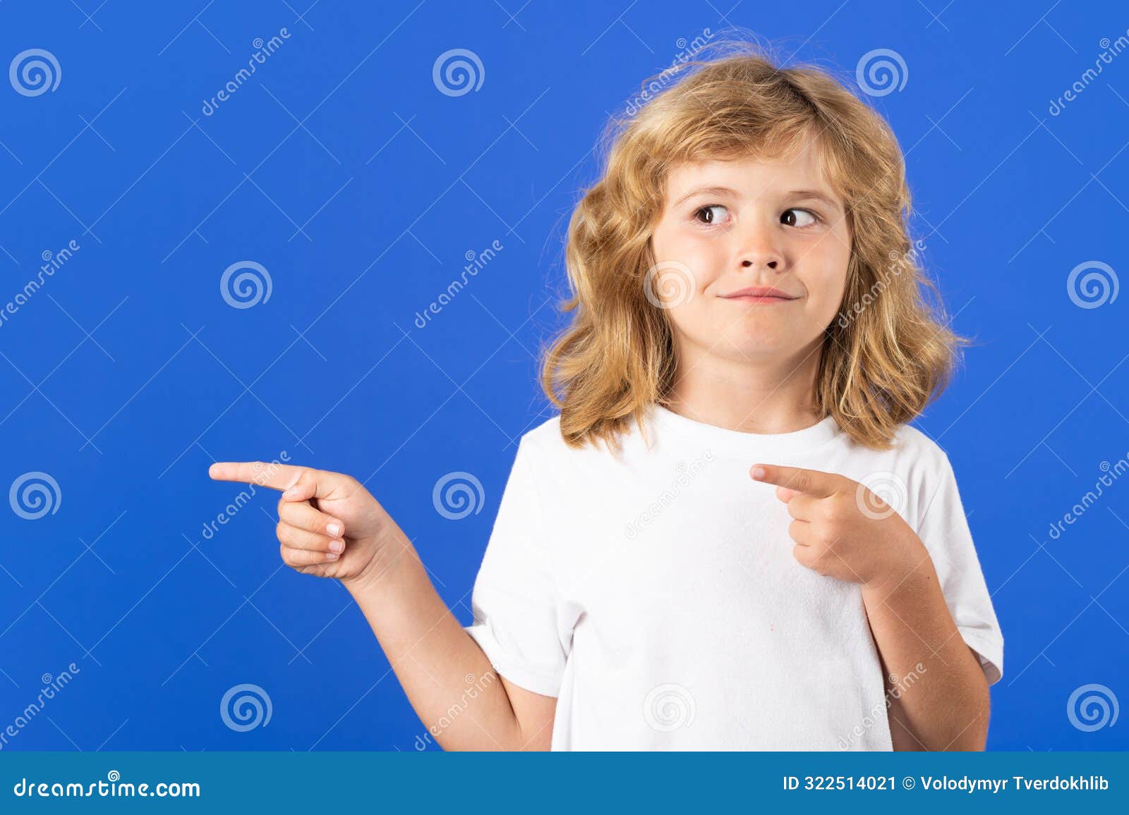Kid Boy Pointing Away on Blue Isolated Studio Background. Kid with ...