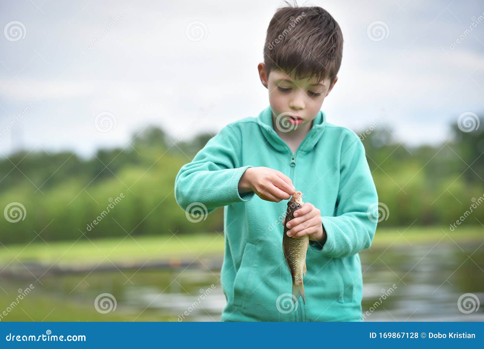 Kid Boy Taking Out a Hook from the Fish Stock Photo - Image of hook ...