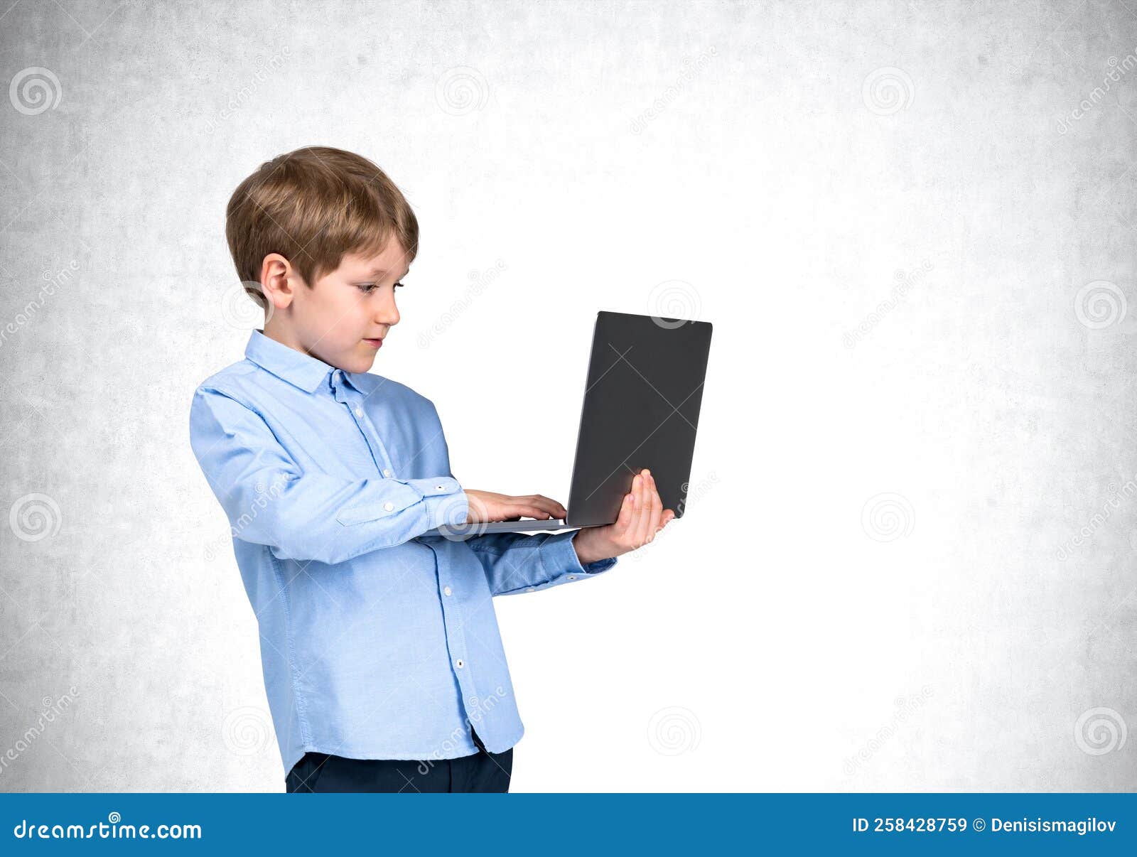 Kid Boy Working with Computer on Grey Concrete Background. Copy Stock ...