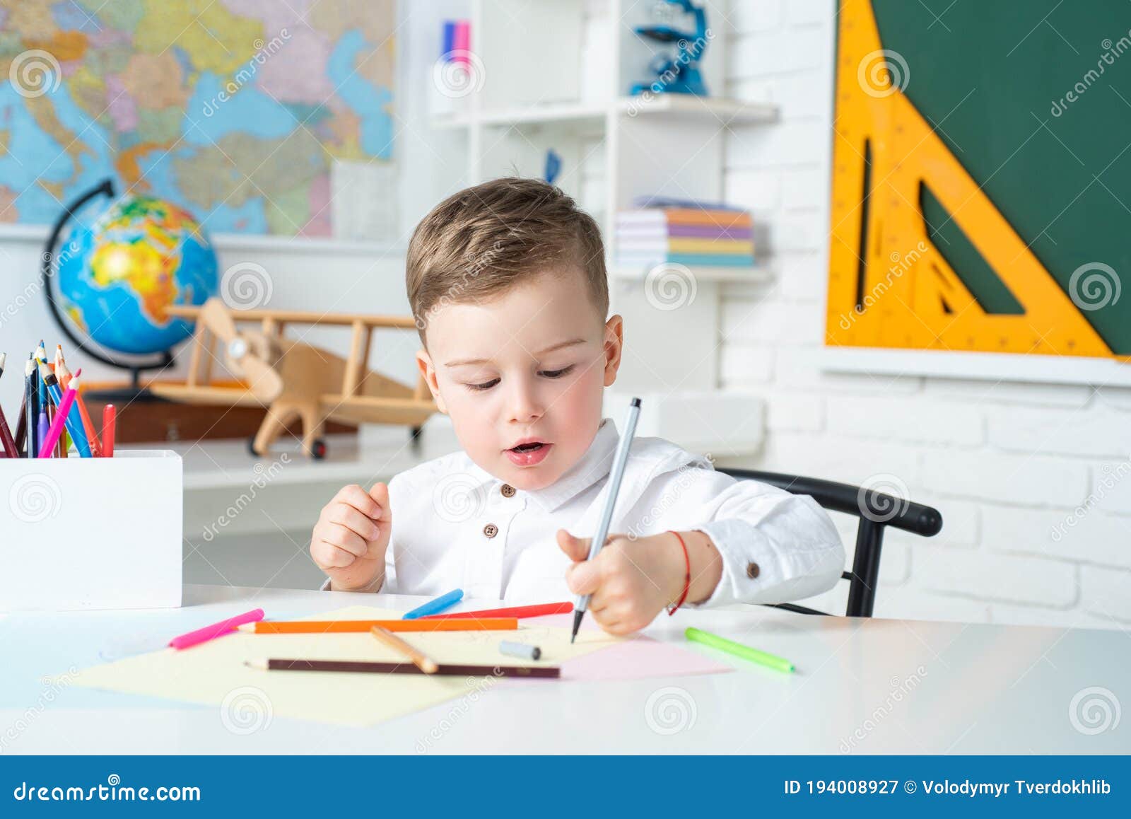 Kid Boy Writing in Classroom. Child of Primary School. Stock Image ...