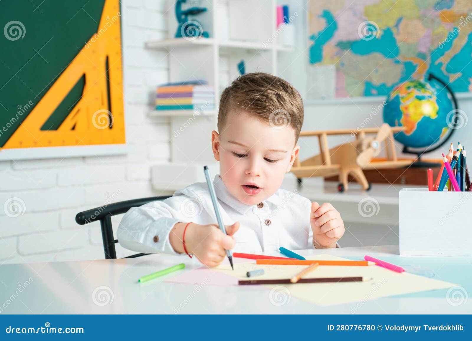 Kid Boy Writing in Classroom. Child of Primary School. Stock Photo ...