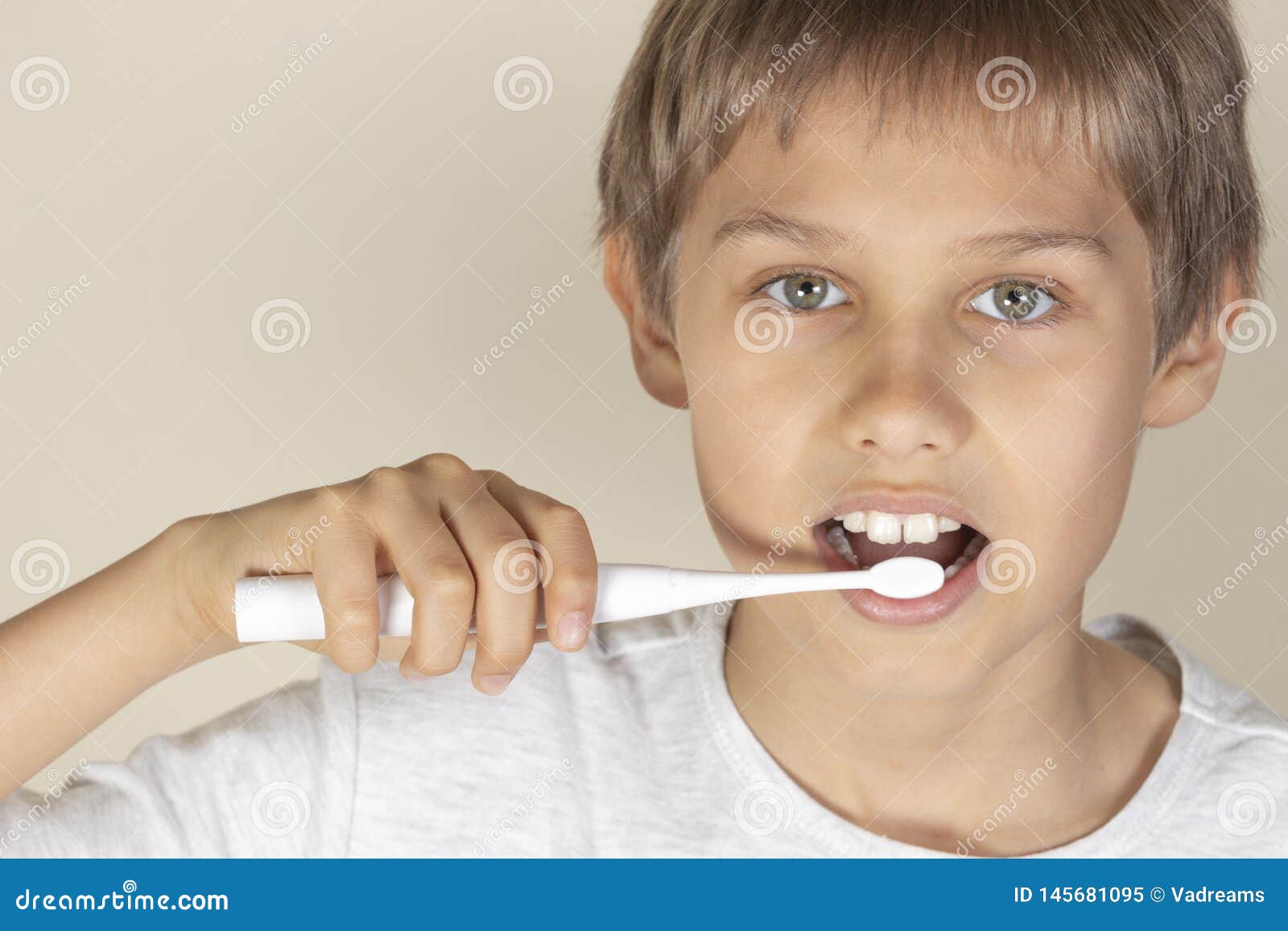 Kid Brushing Teeth with White Electric Toothbrush Stock Image - Image ...