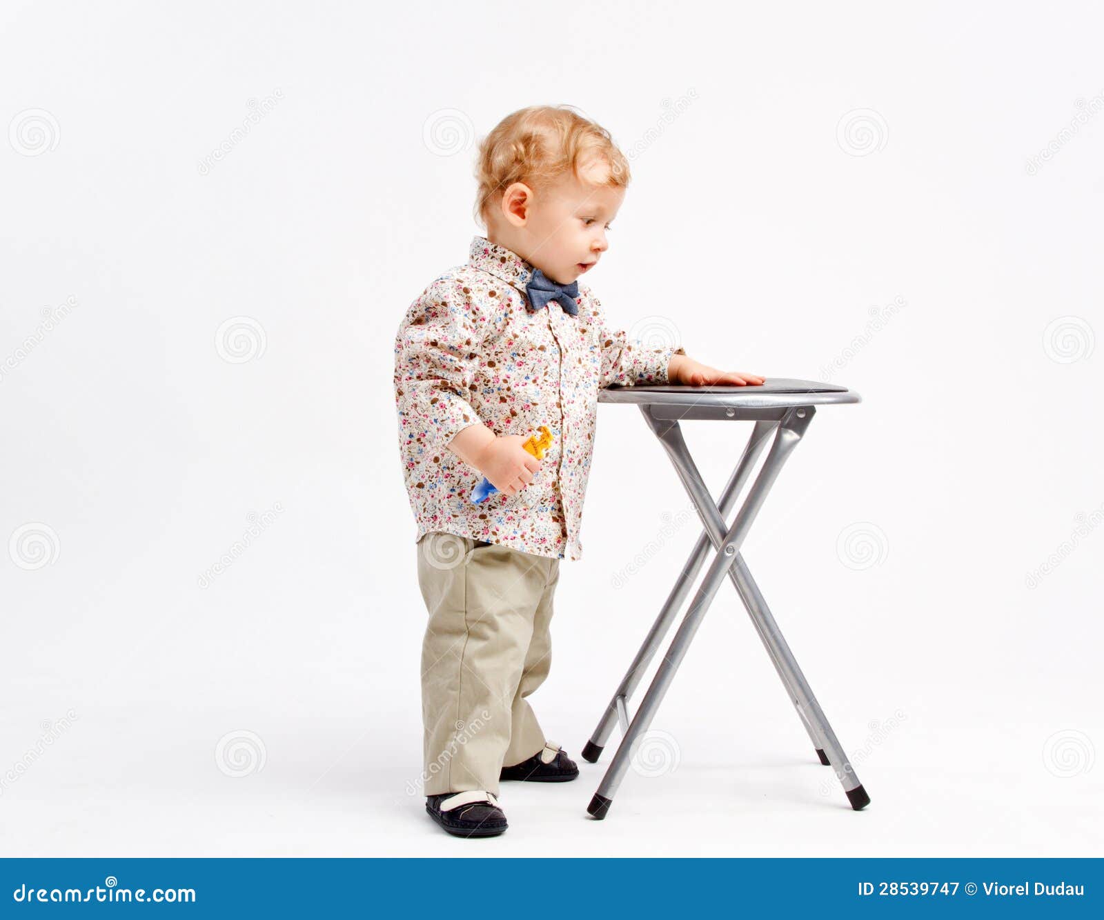 Kid comparing with a stool stock image. Image of chair - 28539747