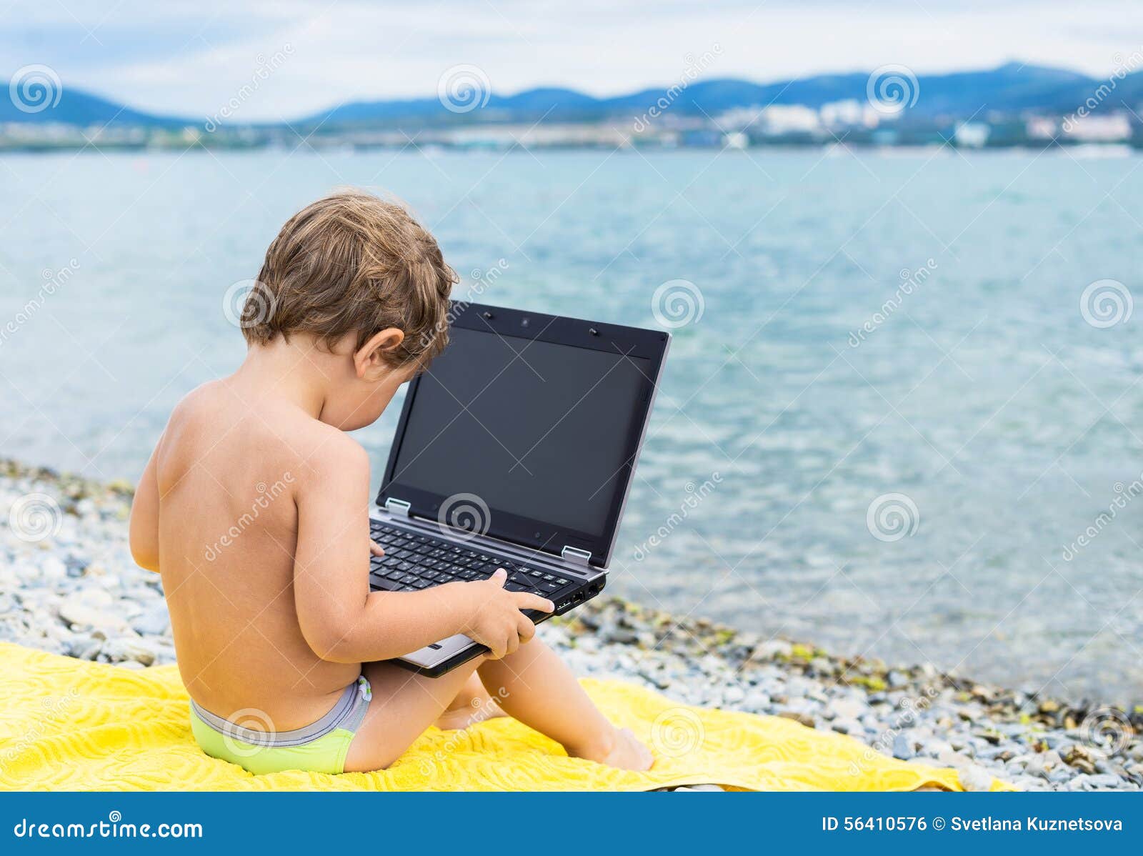 Kid with Computer on Beach Near Sea Stock Photo - Image of pebbles ...