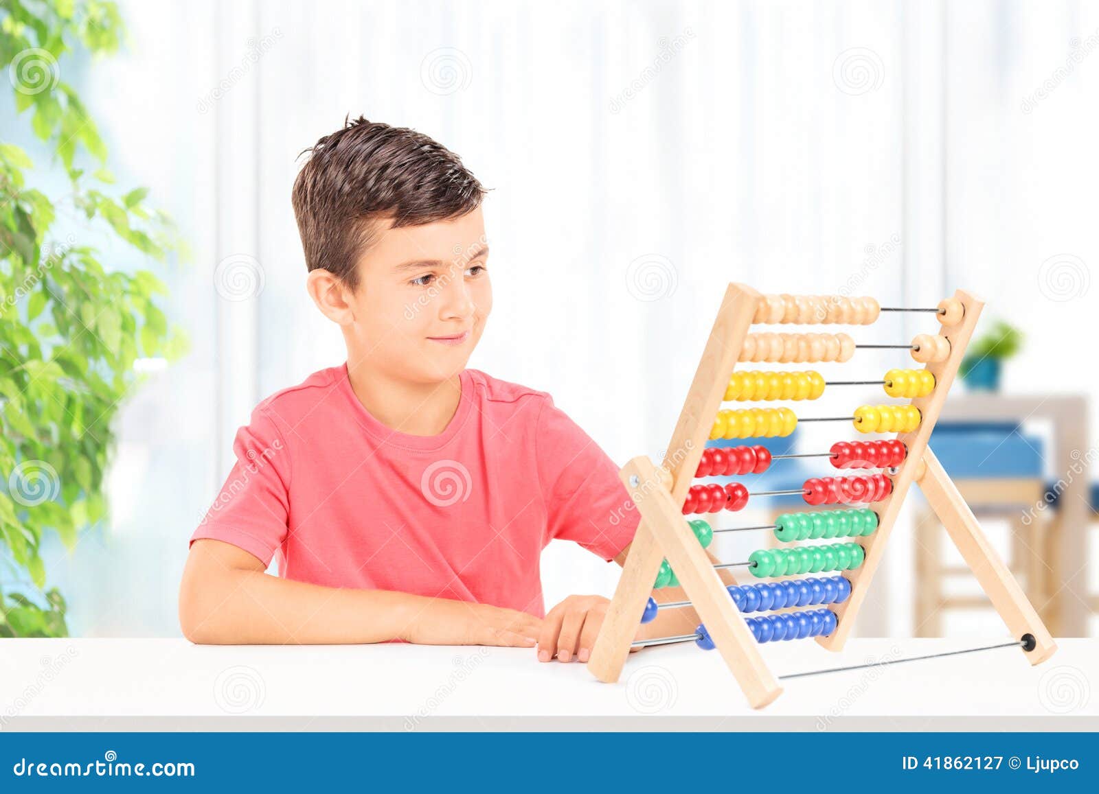 Kid Counting with Abacus Seated on Table at Home Stock Image - Image of ...