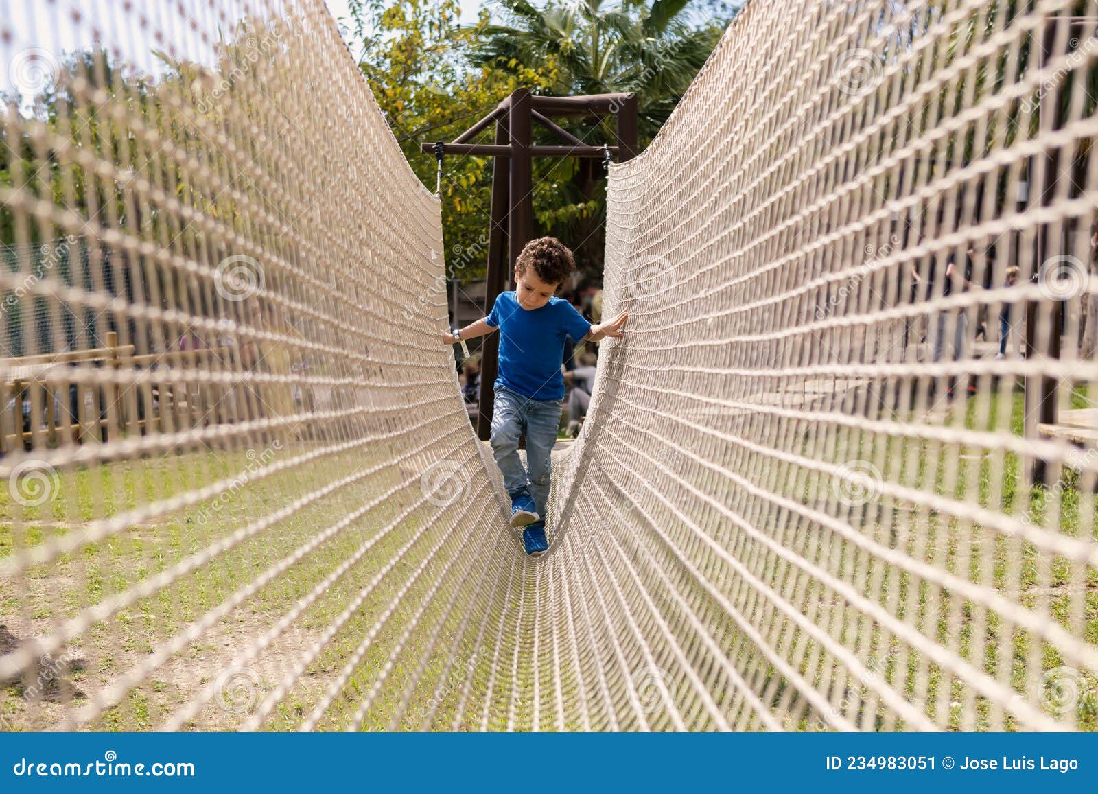Kid Crossing a Net Bridge. Development of the Child`s Agility and ...