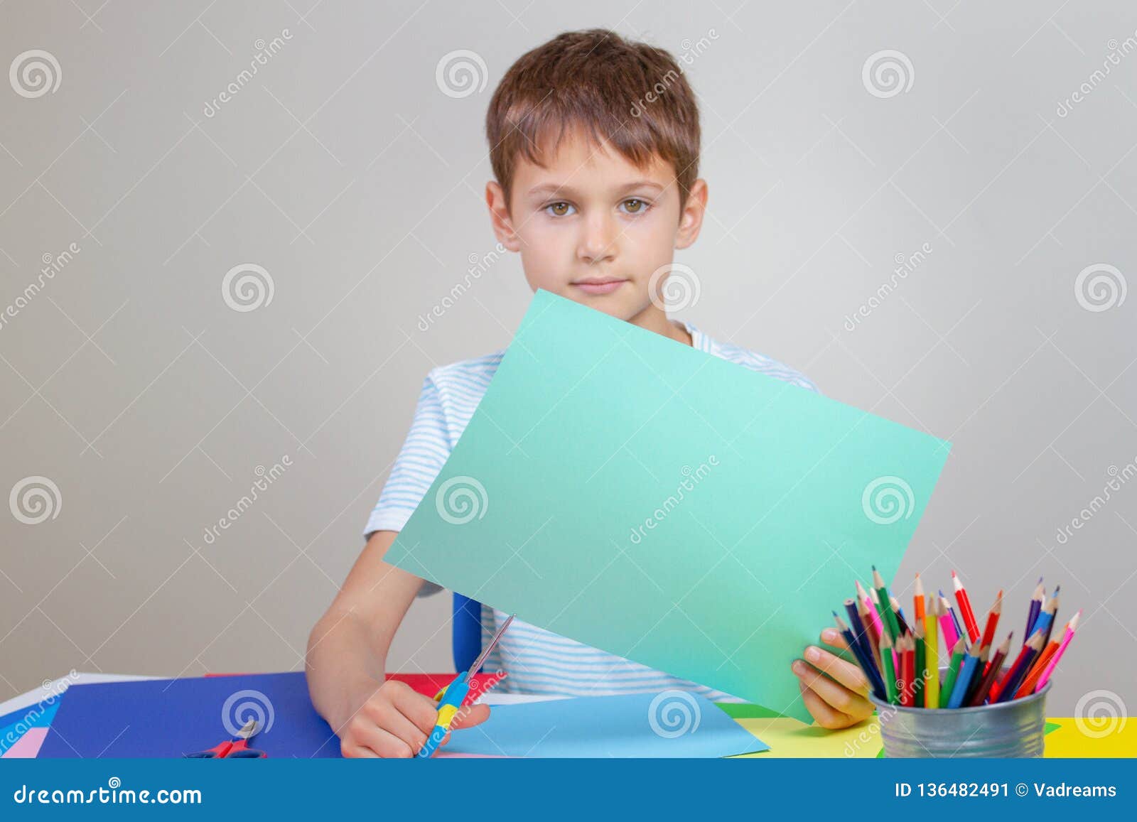 Kid Cutting Colored Paper with Scissors at the Table Stock Image ...