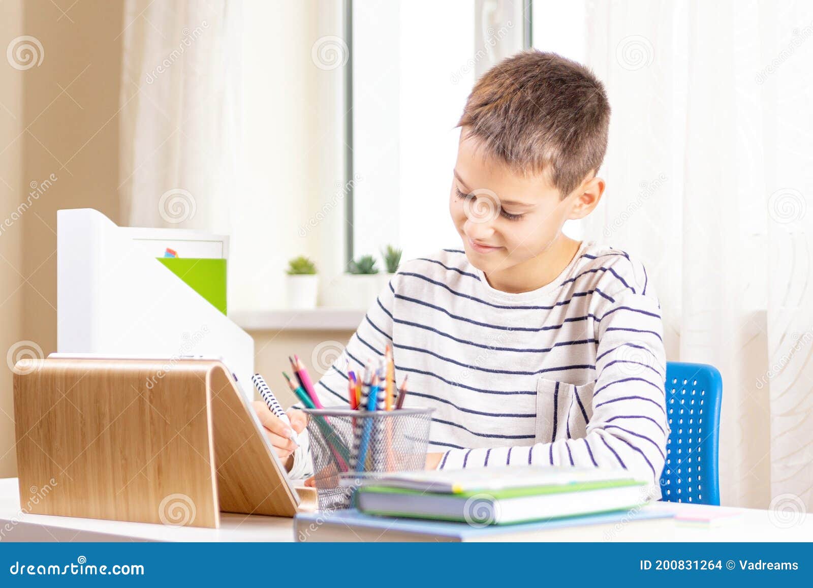 Kid with Digital Tablet Computer Writing, Doing Homework at Table at ...