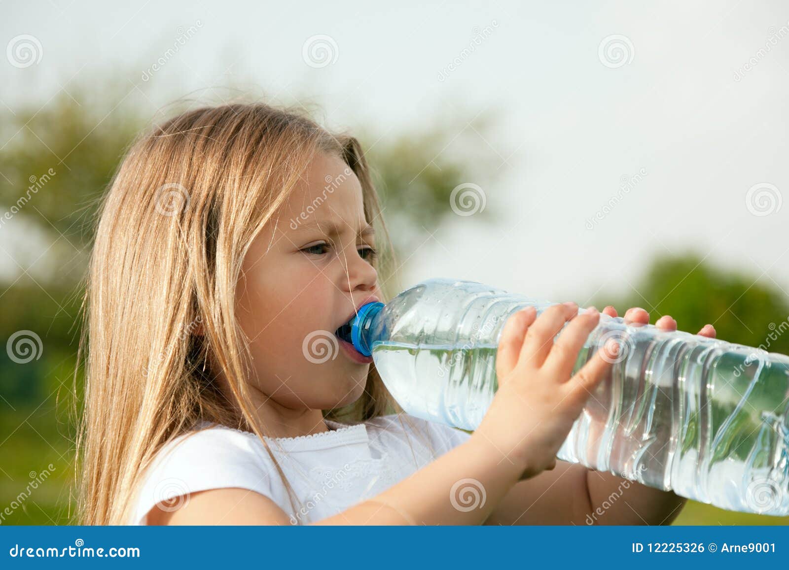 Kid drinking bottled water stock photo. Image of little - 12225326