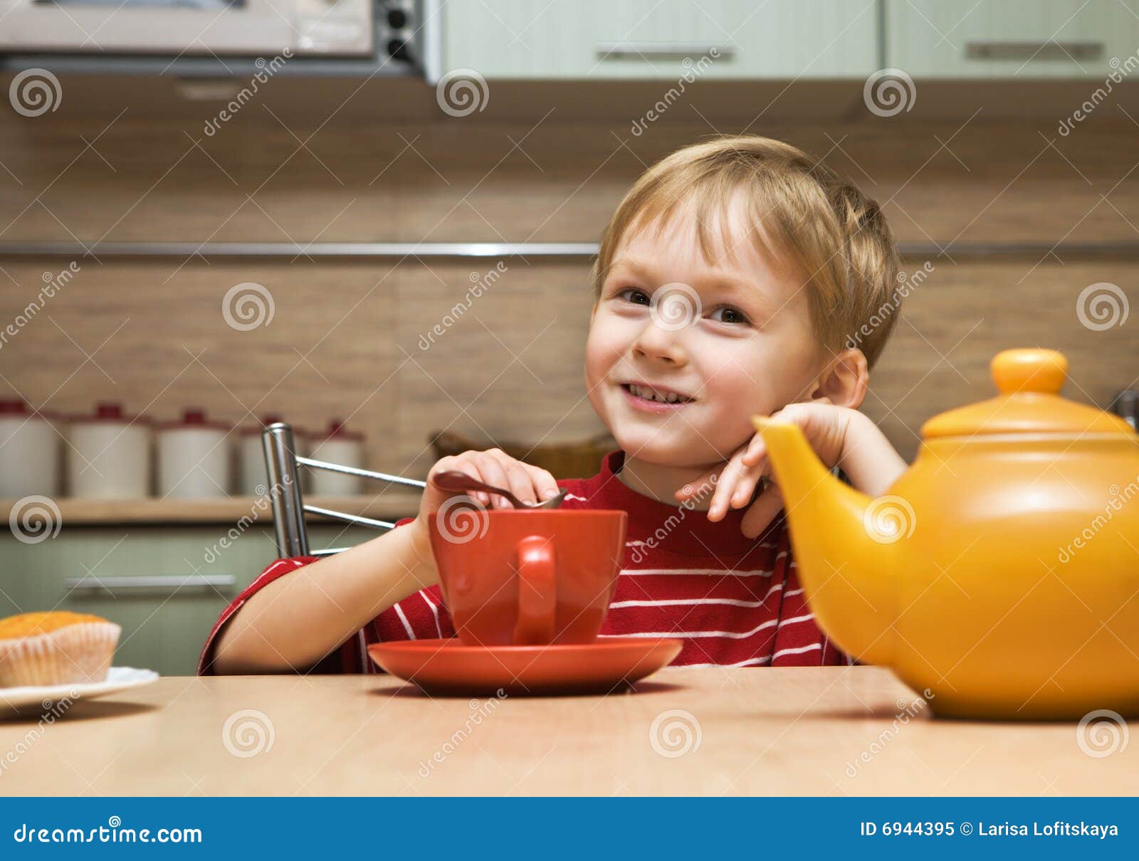 Kid drinks tea with cakes stock image. Image of person - 6944395