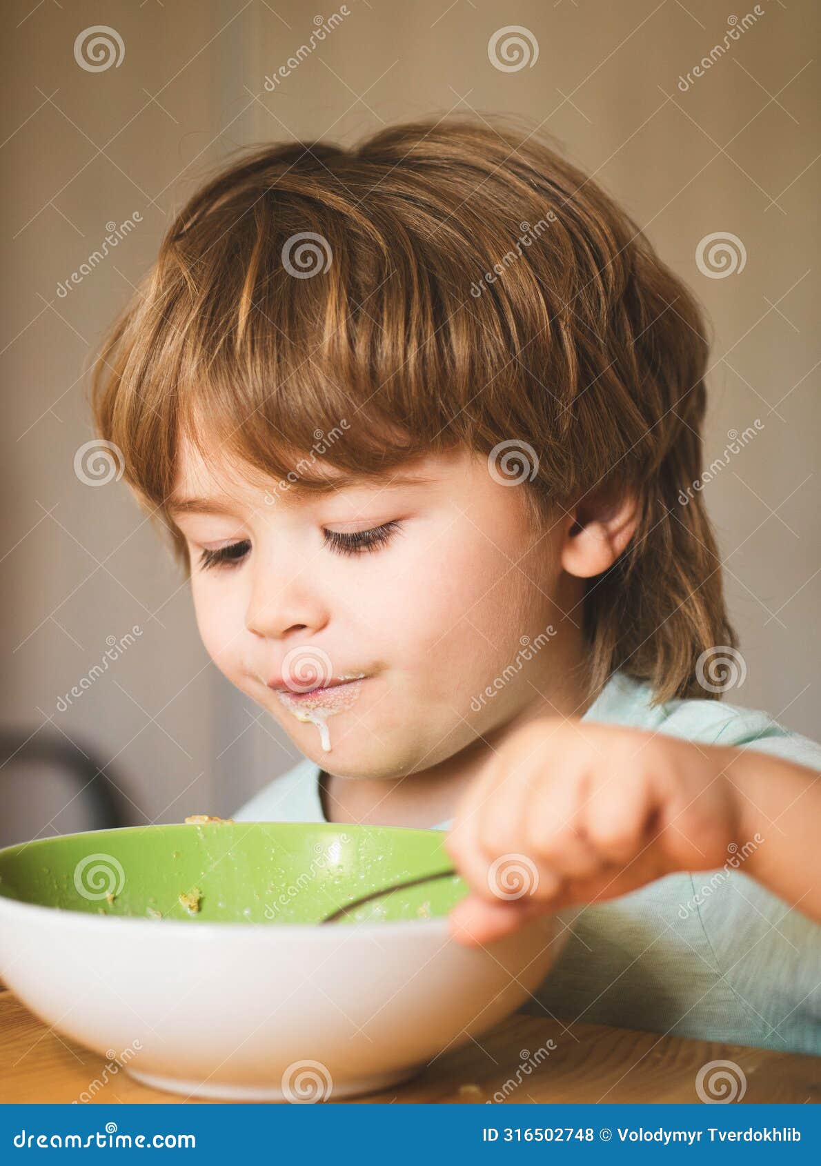 Kid Eating. Little Boy Having Breakfast in the Kitchen. Stock Photo ...