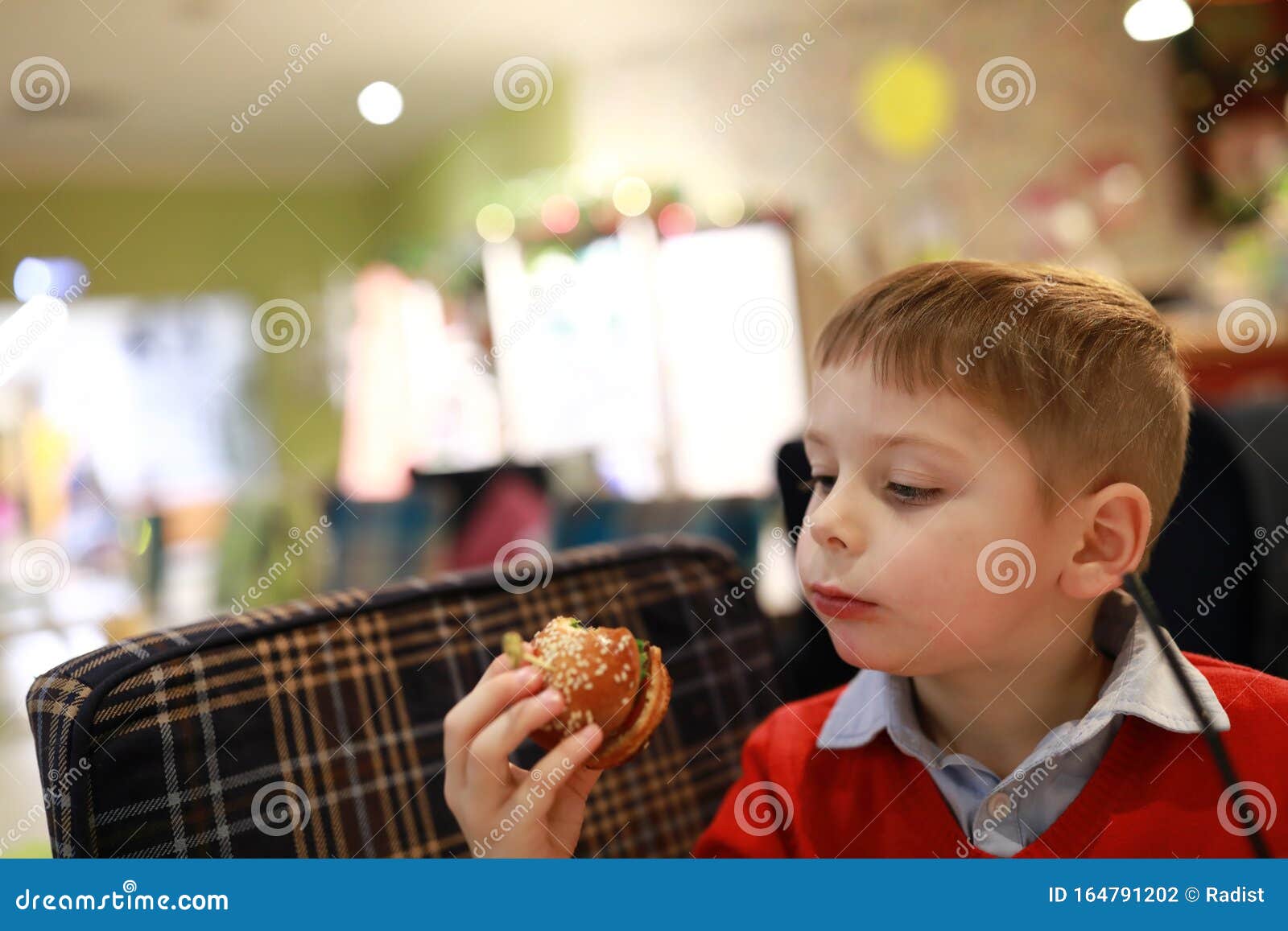 Kid eating mini burger stock photo. Image of junky, delicious - 164791202