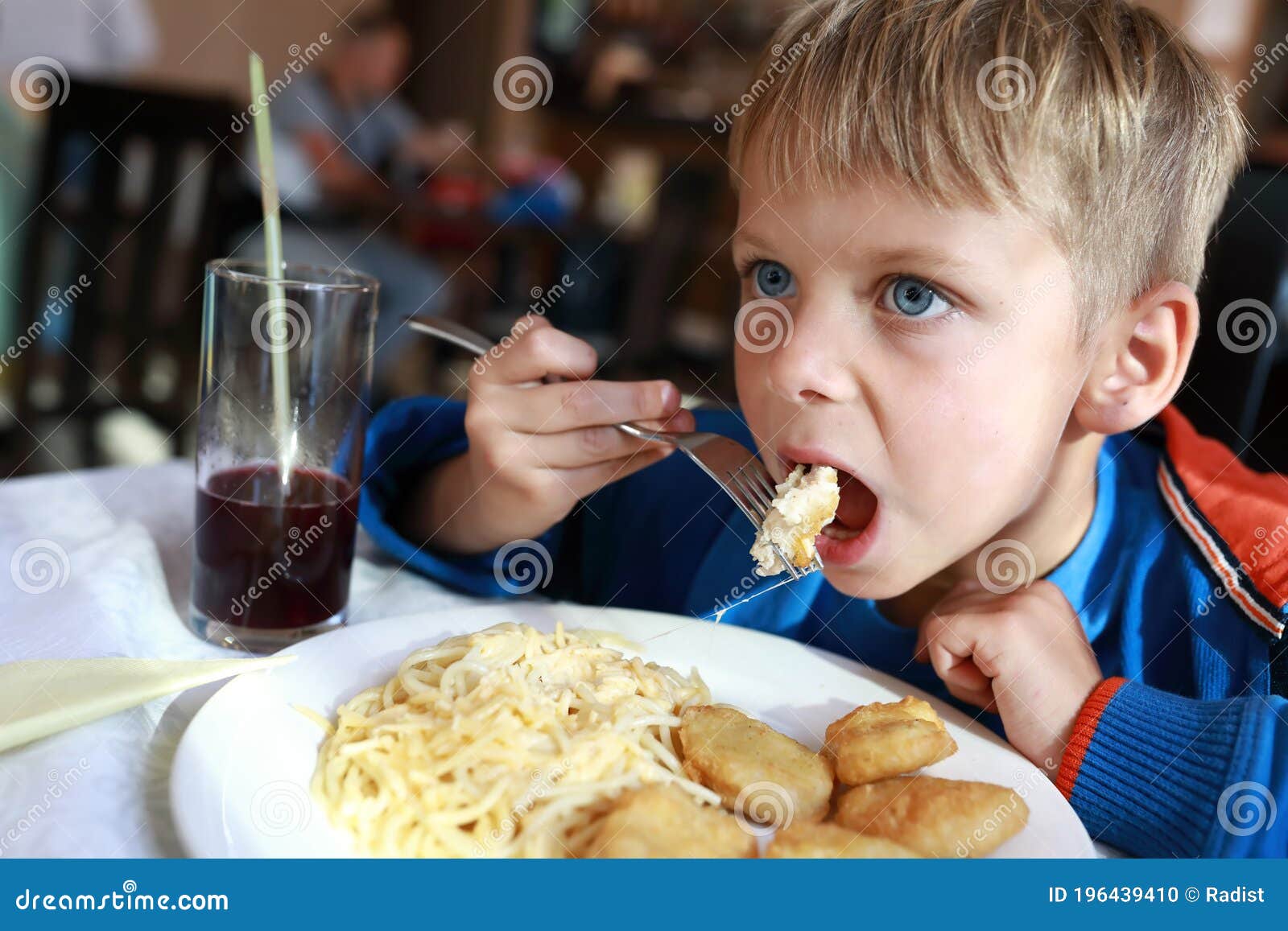 Kid Eating Nuggets with Spaghetti Stock Photo - Image of cheese, eating ...