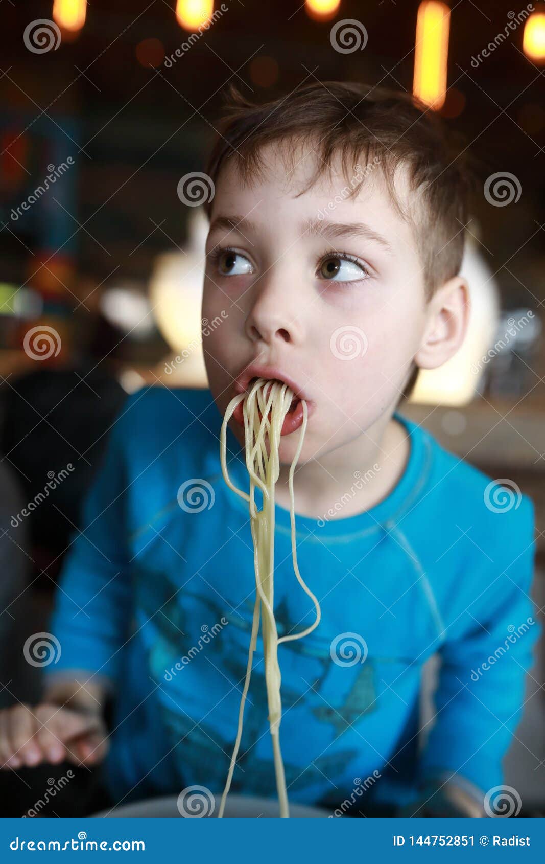 Kid eating spaghetti stock image. Image of cute, appetizer - 144752851