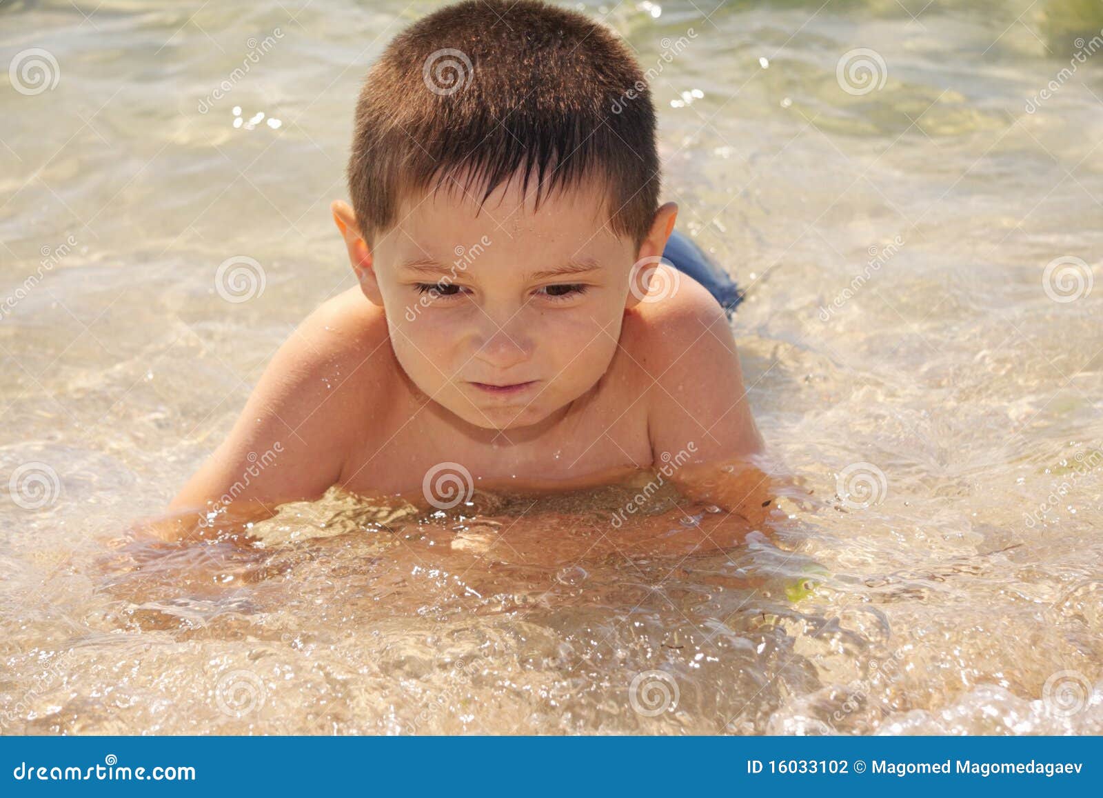 Kid enjoying sea bathing stock photo. Image of laying - 16033102