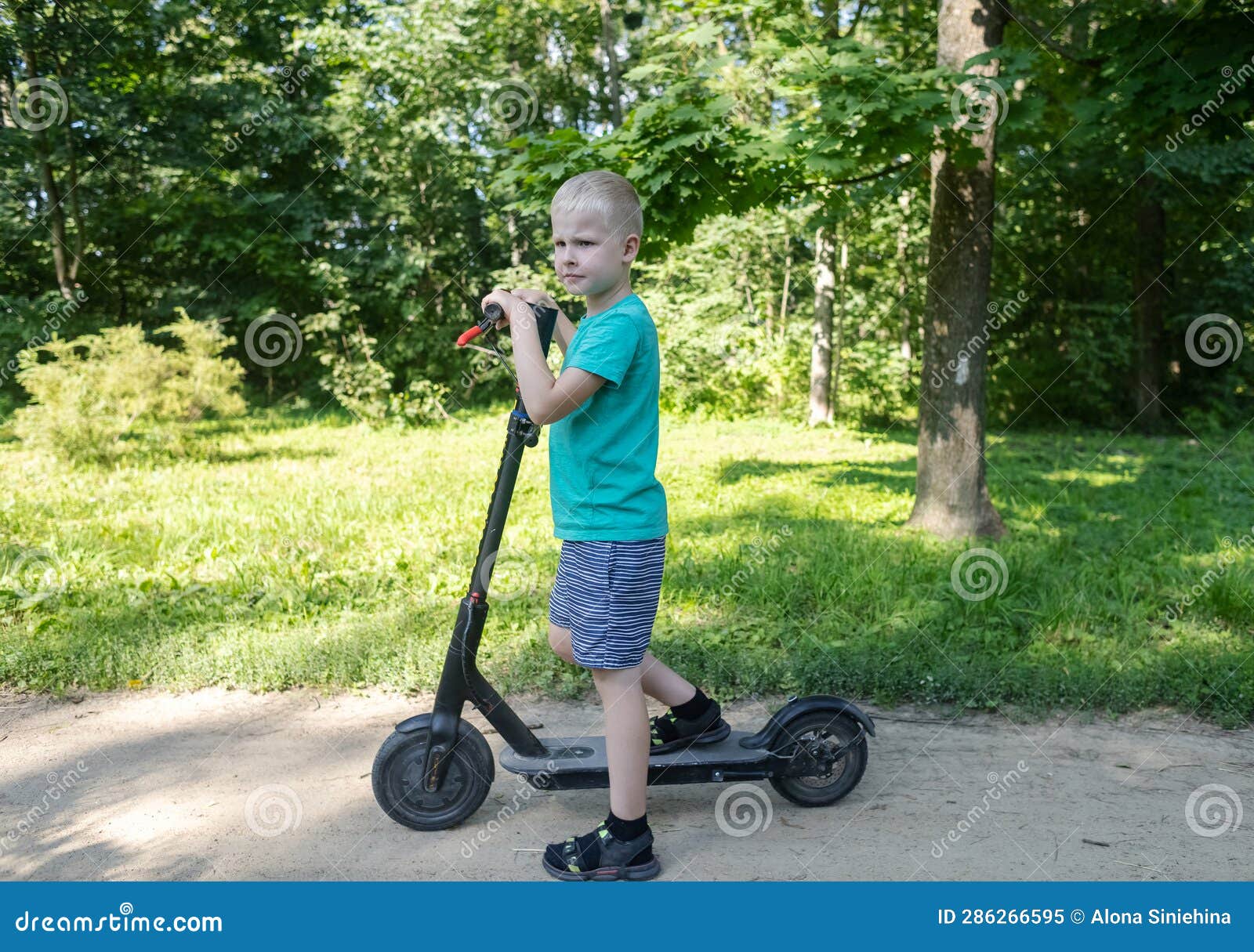 Kid Fall when Riding an Electric Scooter. Riding an E-scooter without ...