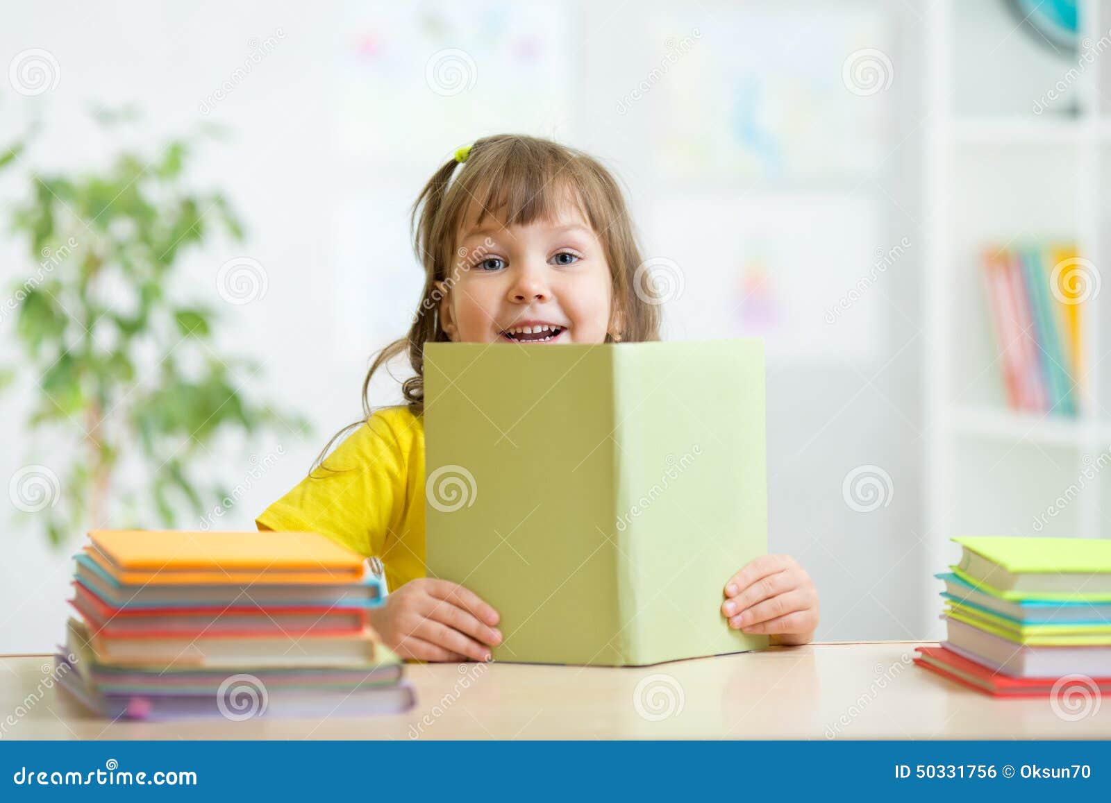 Kid girl with open book stock photo. Image of indoor - 50331756