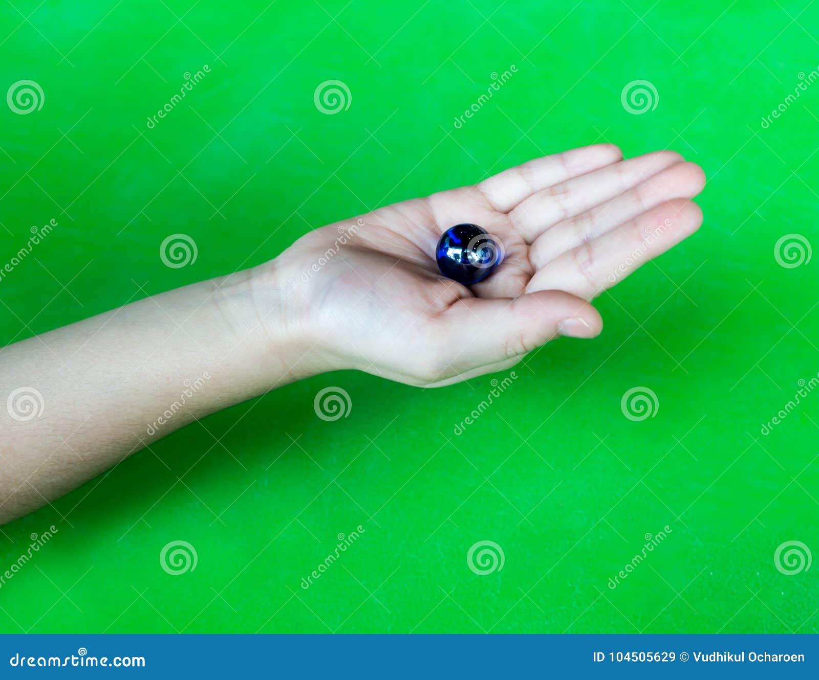 Kid Hand Holding Blue Glass Marble with a Reflection Stock Image ...