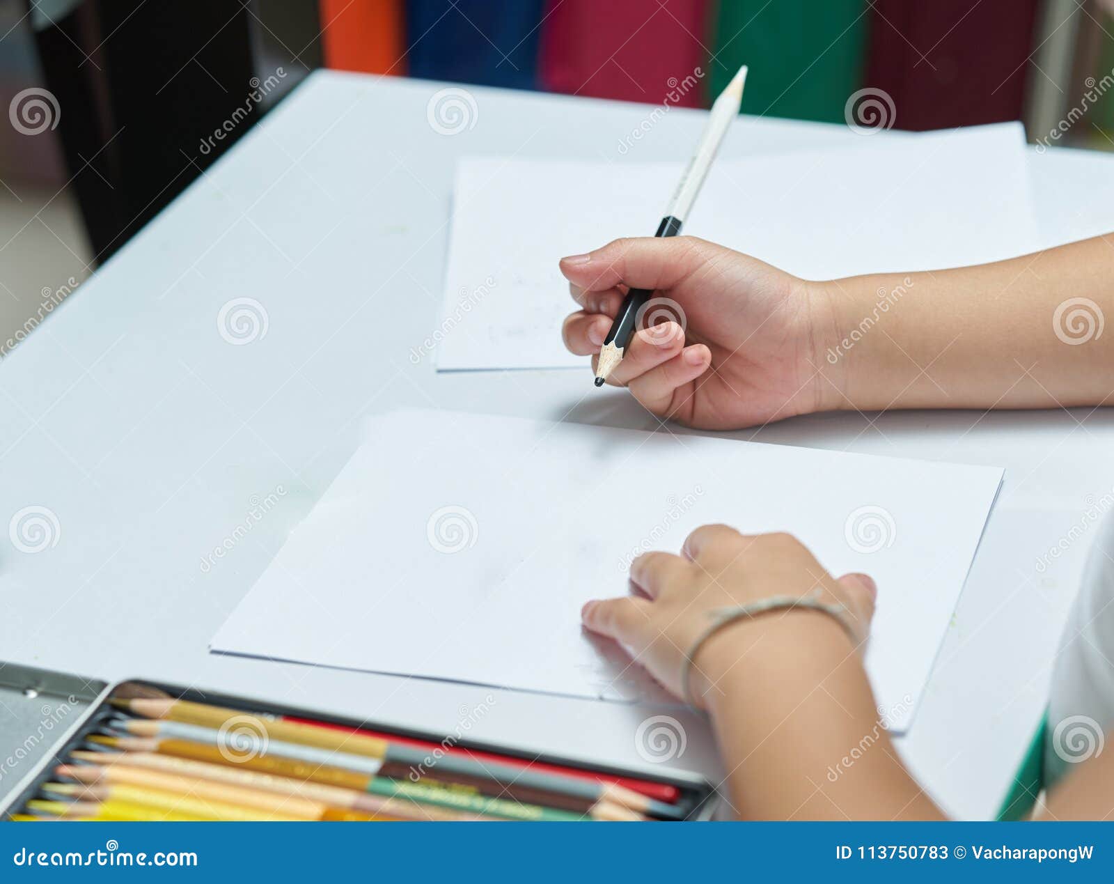 Kid Hands Holds Color Pencil and Think about Writing Things on W Stock ...