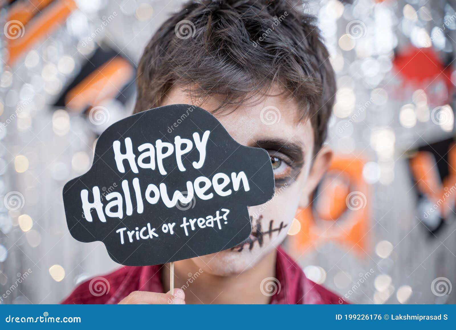 Kid Hloding Halloween Booth Prop Infront of Spooky Face - Concept of ...