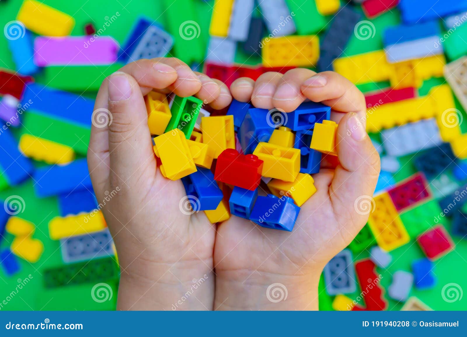 A Kid Holding Small Pieces of Interlocking Plastic Colorful Bricks Toy ...