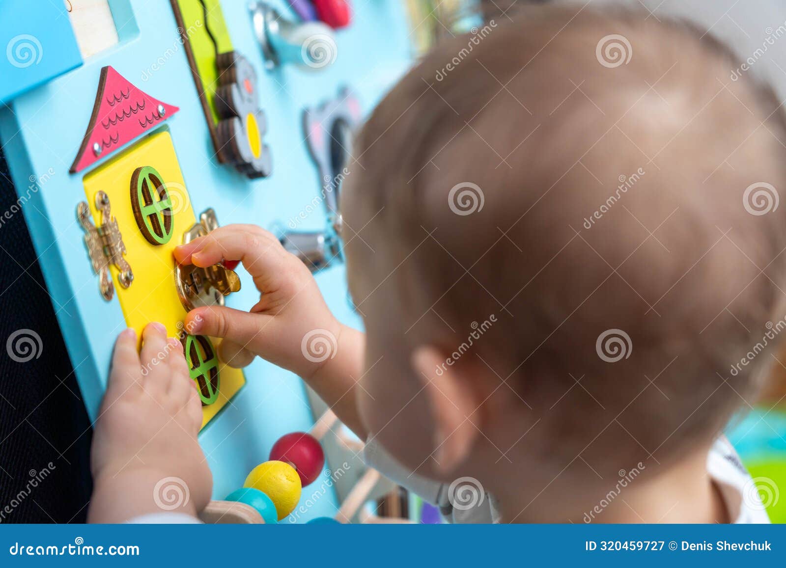 The Kid is Intently Trying To Open the Lock on the Game Board Stock ...