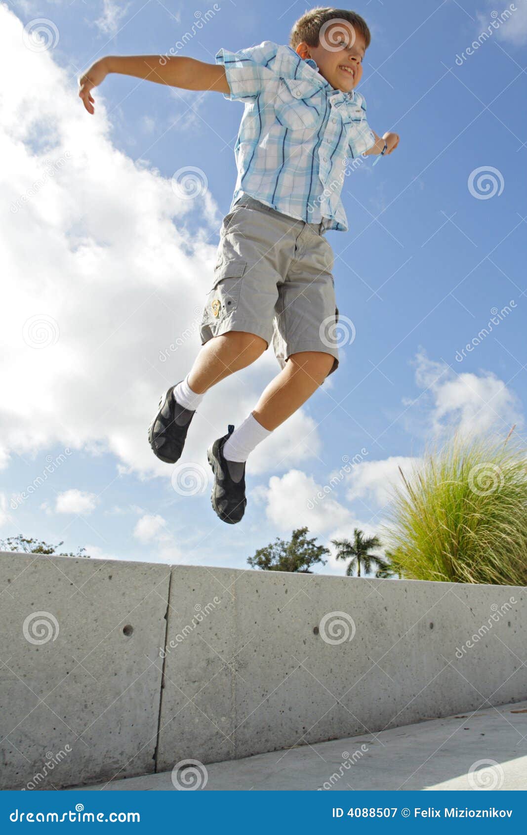 Kid jumping from a ledge stock image. Image of youth, outdoors - 4088507