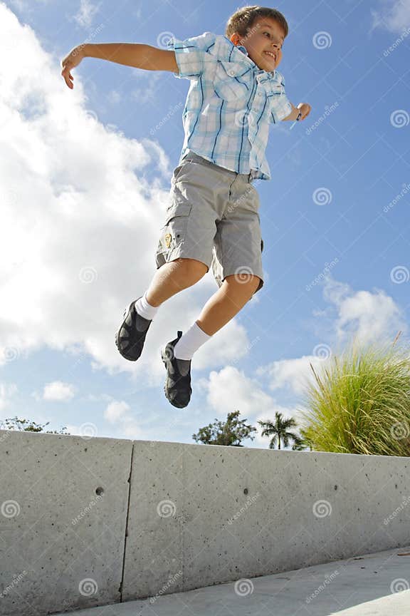 Kid jumping from a ledge stock image. Image of youth, outdoors - 4088507