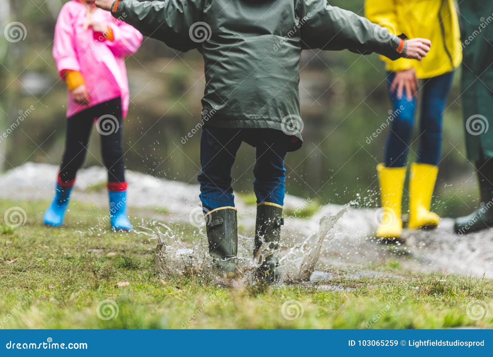 Kid Jumping in Muddy Puddle Stock Image - Image of season, raincoats ...