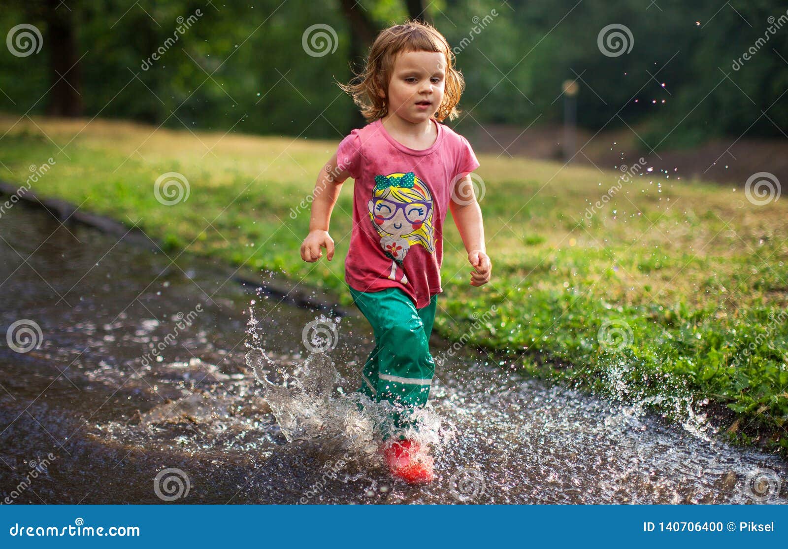 Kid Jumping into Water Puddle Stock Photo - Image of outdoor, boots ...