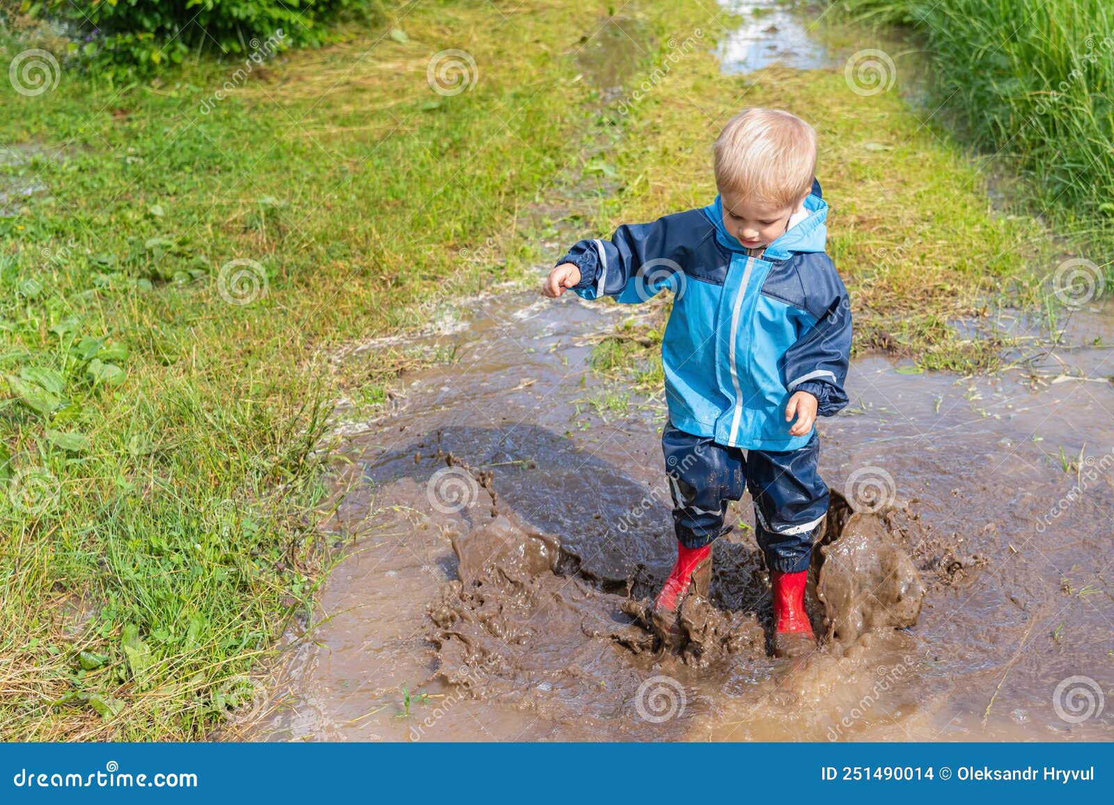 A Kid Jumps into a Dirty Puddle. after the Rain Stock Photo - Image of ...
