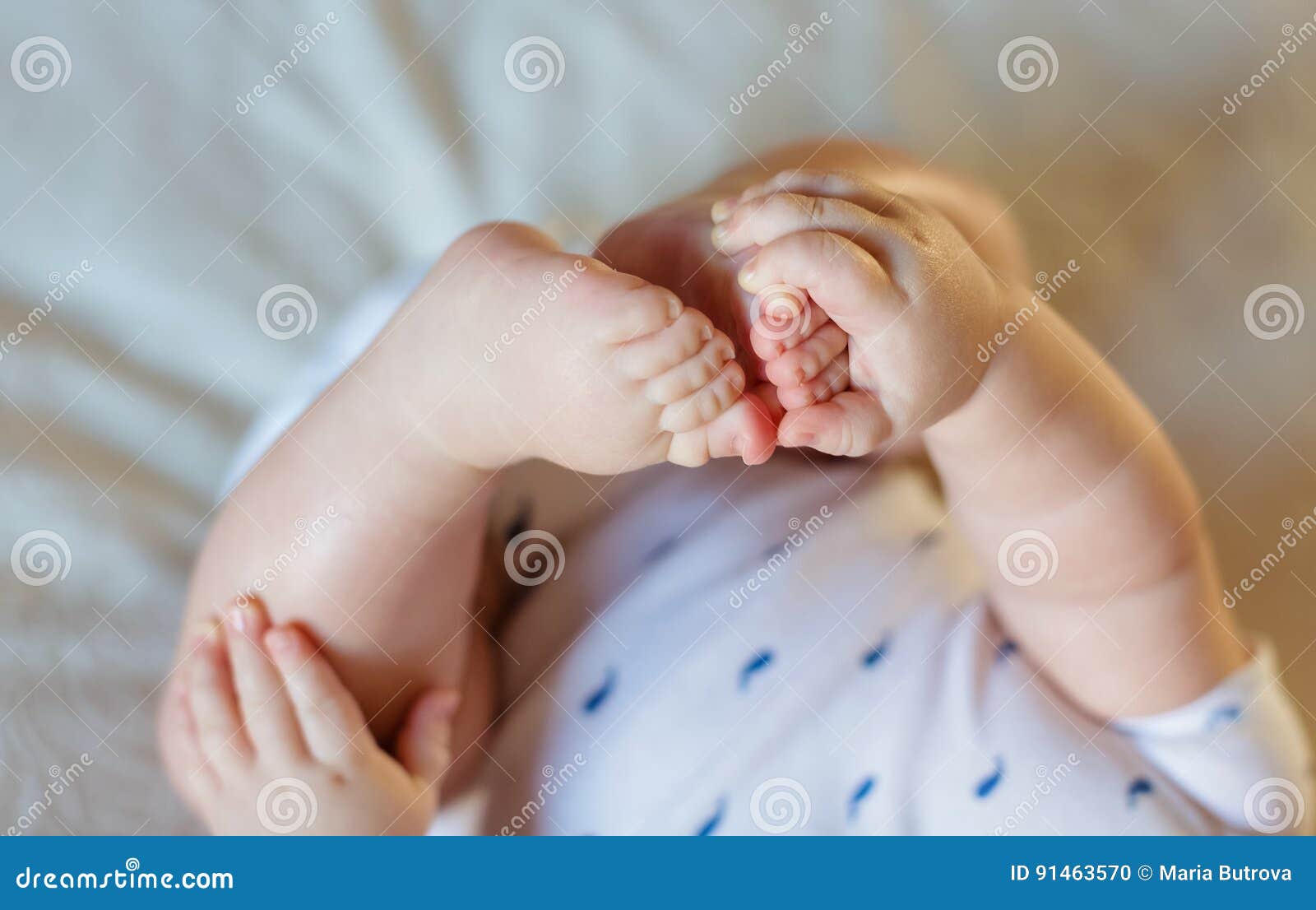The Kid Keeps Handles Their Little Legs, Closeup Stock Photo - Image of ...