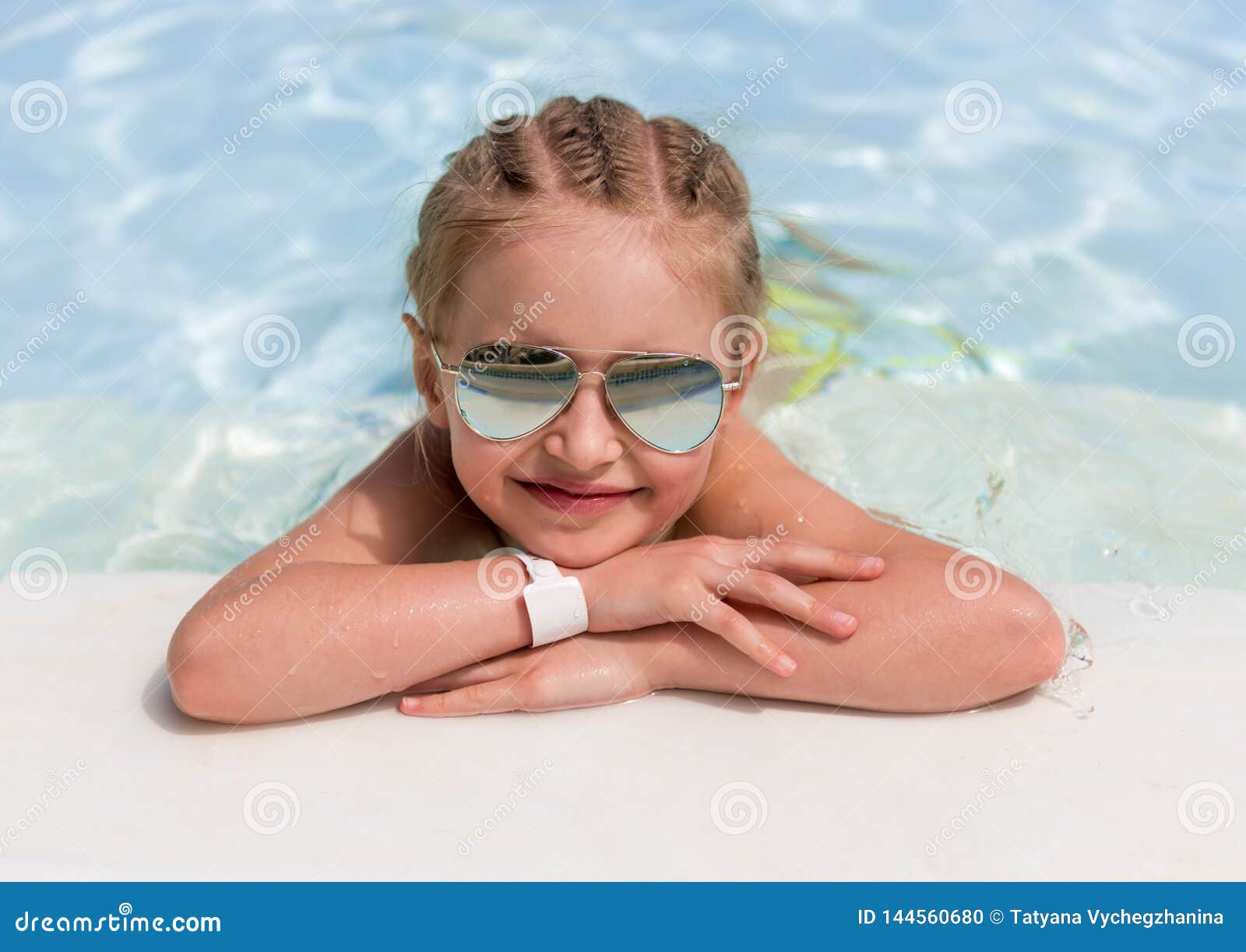 Kid laying on the poolside stock photo. Image of cheerful - 144560680