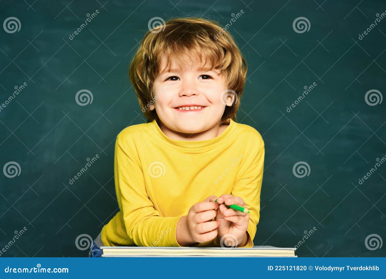 Kid is Learning in Class on Background of Blackboard. Educational ...