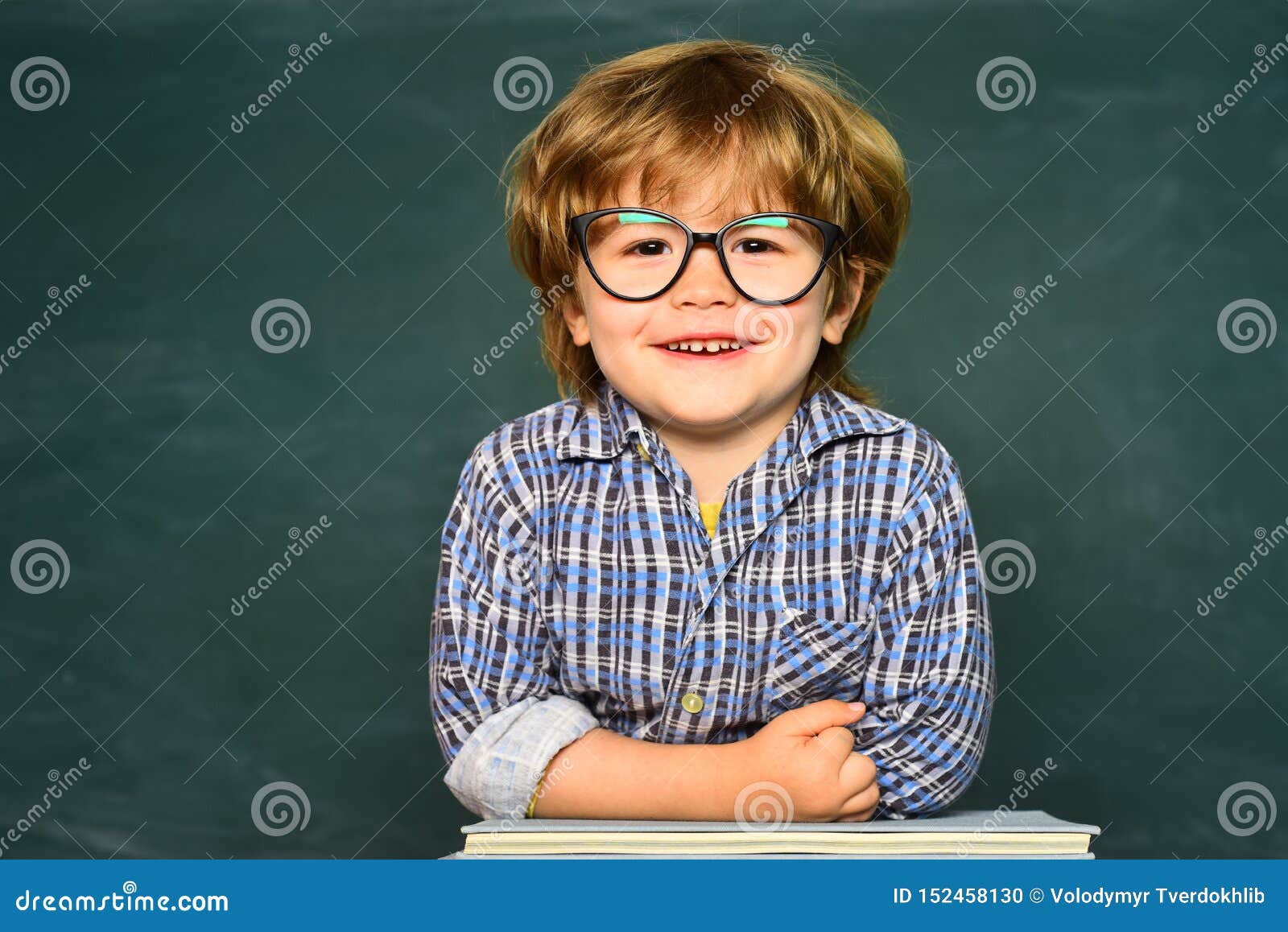 Kid is Learning in Class on Background of Blackboard. Learning at Home ... Kid is Learning in Class on Background of Blackboard. Learning at Home ...