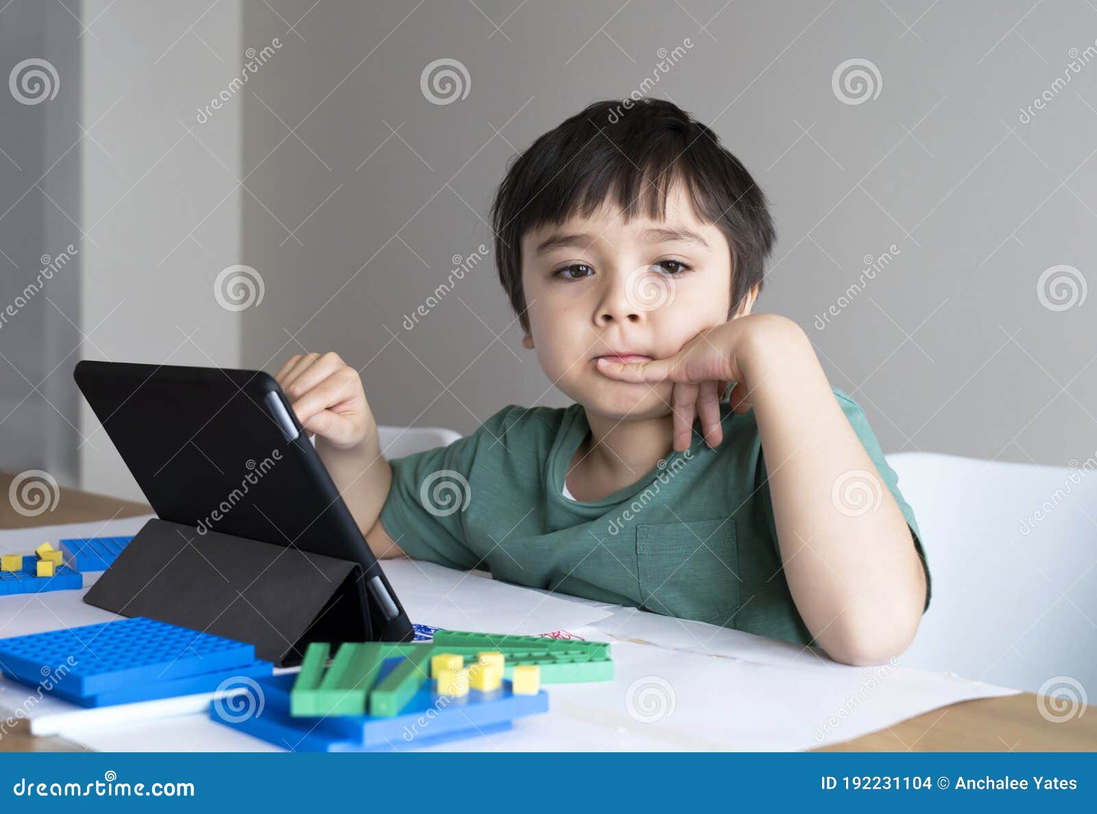 Kid Learning Math Online on Tablet and Using Plastic Block Counting ...