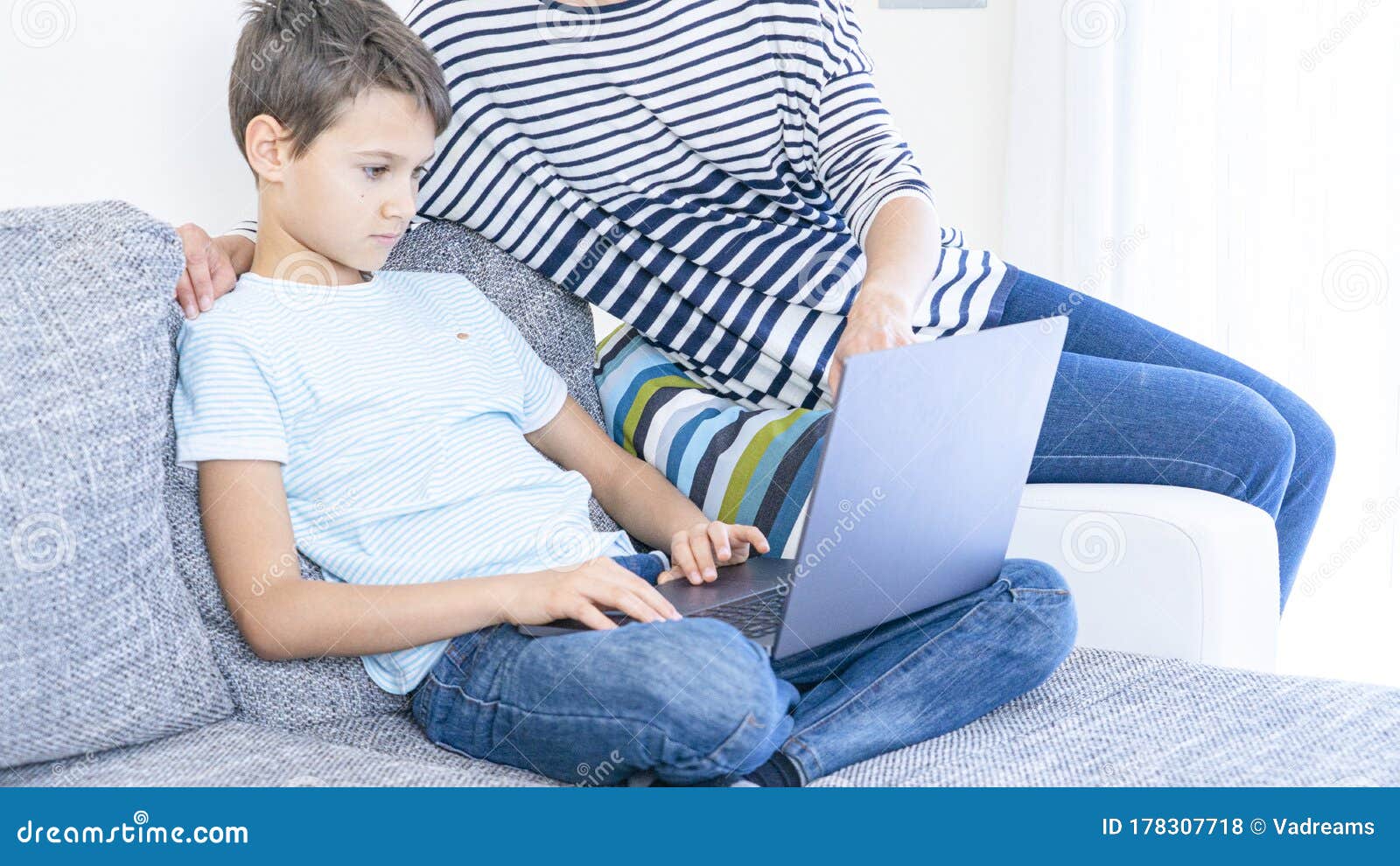 Kid Learning Online with Laptop Computer at Home. Mother Help Him ...