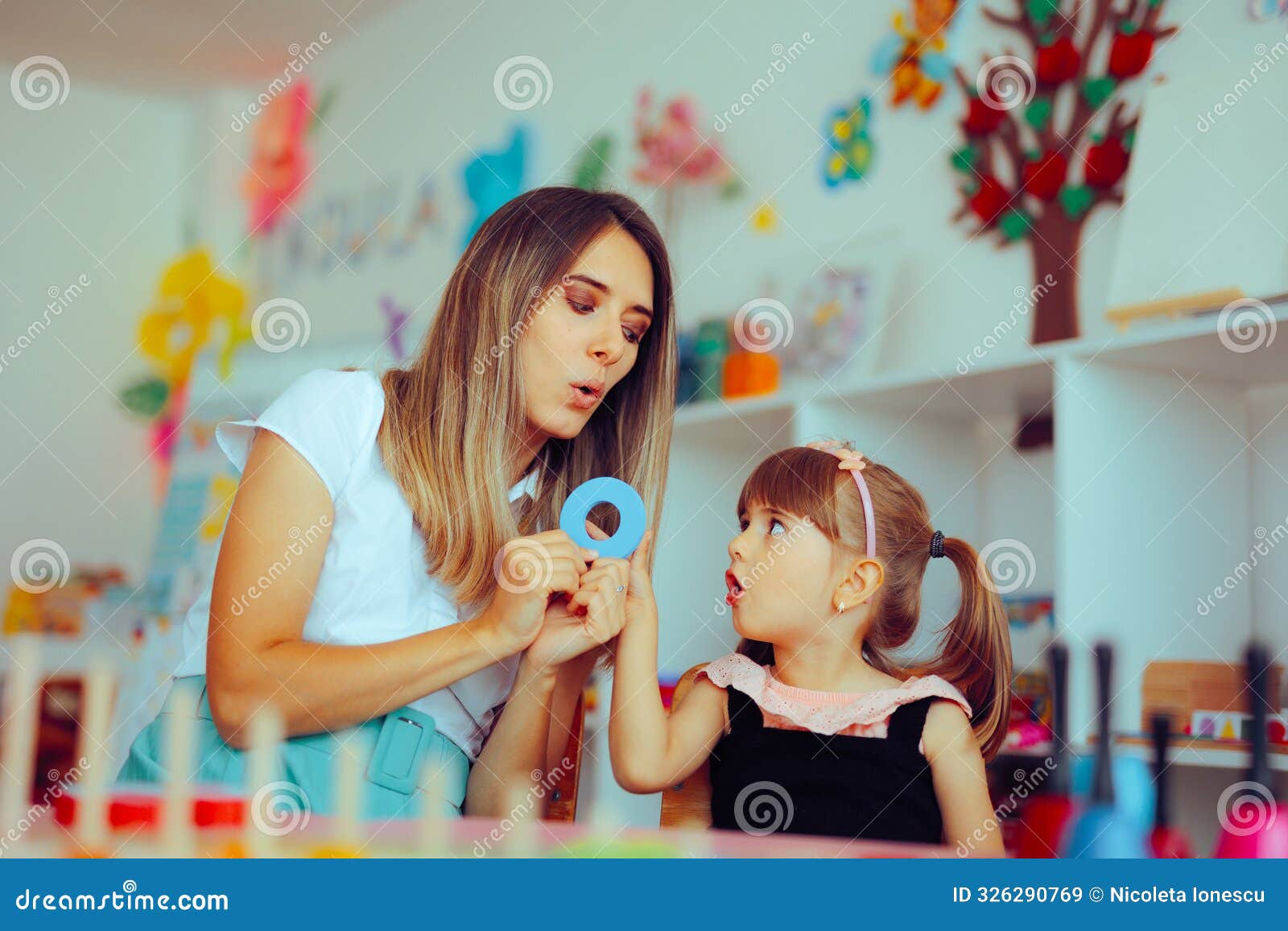 Speech Therapist Teaching a Child the Correct Pronunciation Stock Image ...