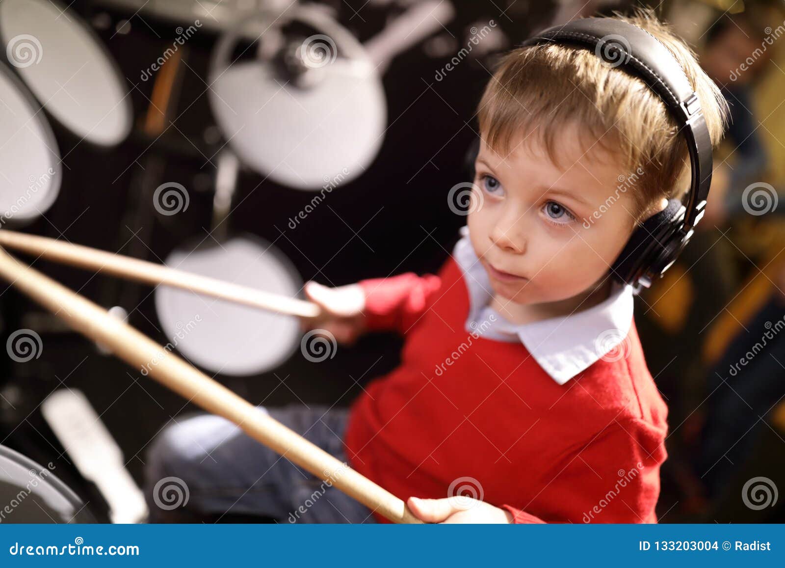 Kid learning to play drums stock photo. Image of play - 133203004