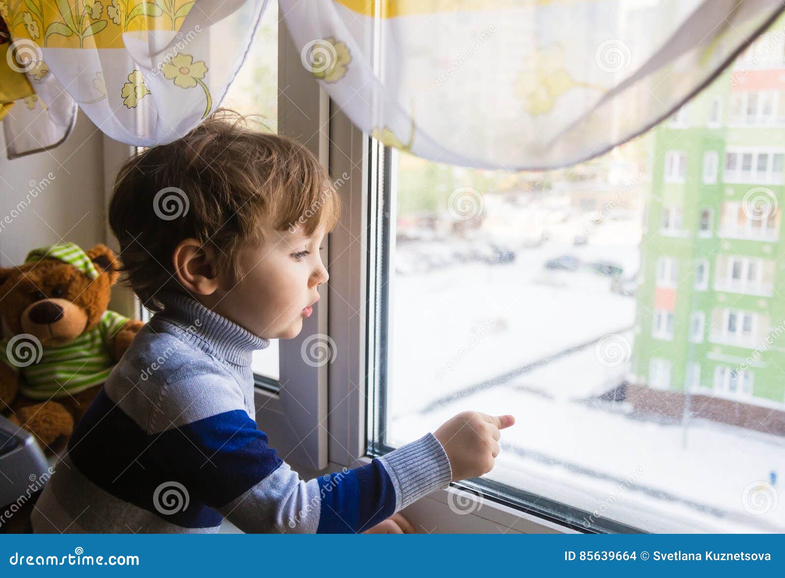 Kid looks out the window stock photo. Image of glass - 85639664