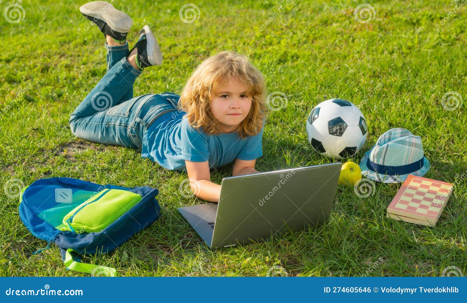 Kid Lying on Grass Using Laptop Notebook. Concept of Outdoor Education ...