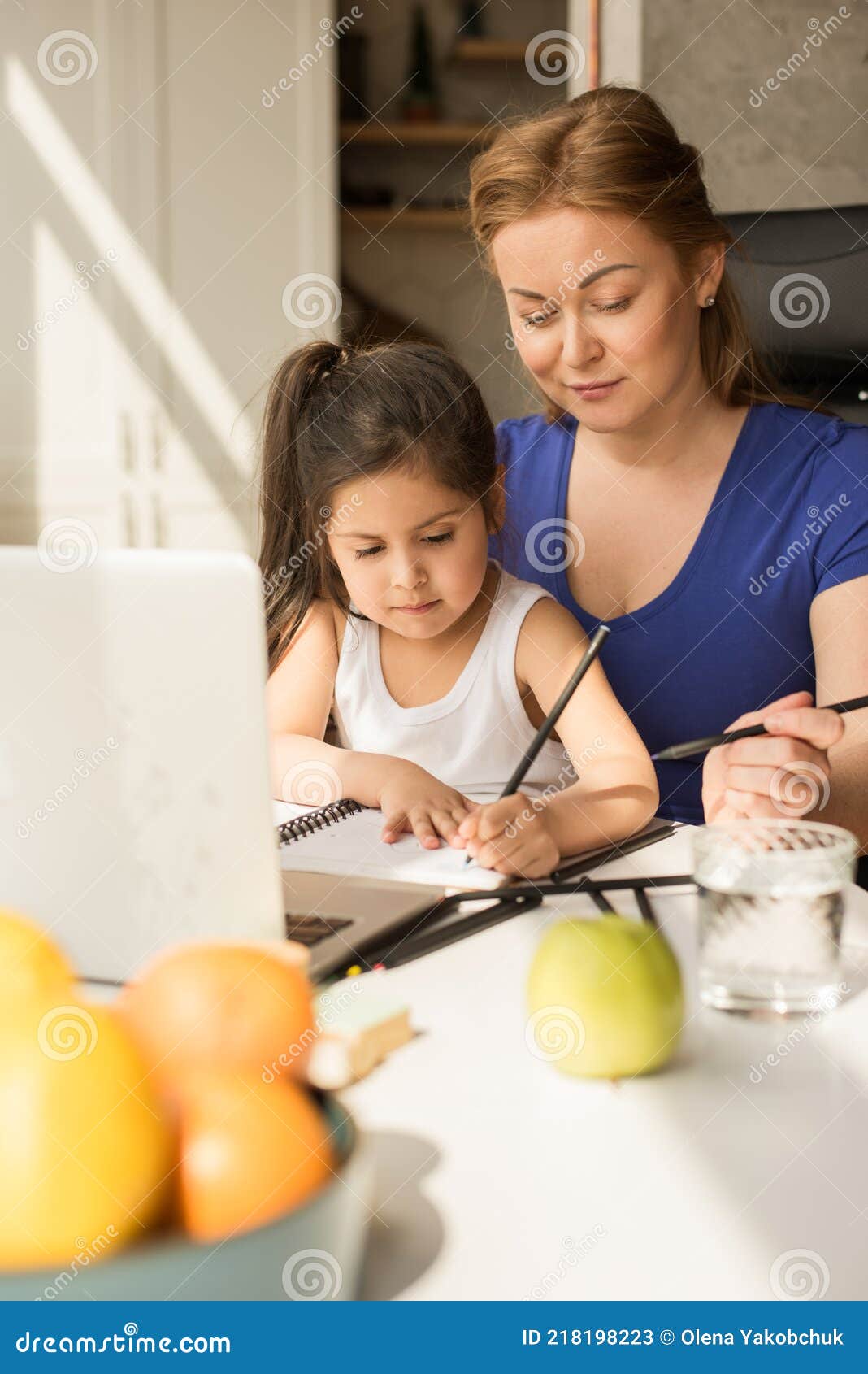 Kid and Mother Watching at the Notebook while Studying and Doing ...