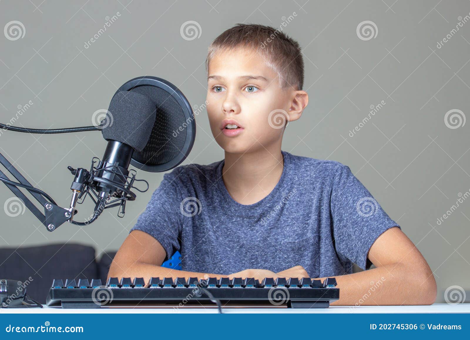 Kid Near Computer Talking into Microphone. Techology, Online Learning ...