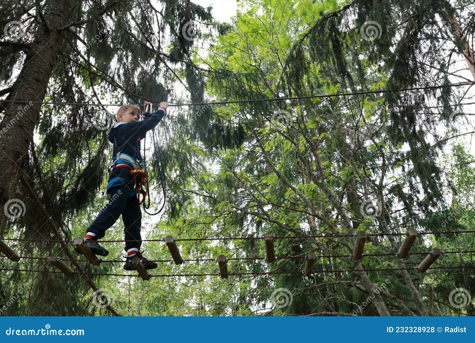 Kid Overcomes Obstacle Course in Forest Stock Photo - Image of ...